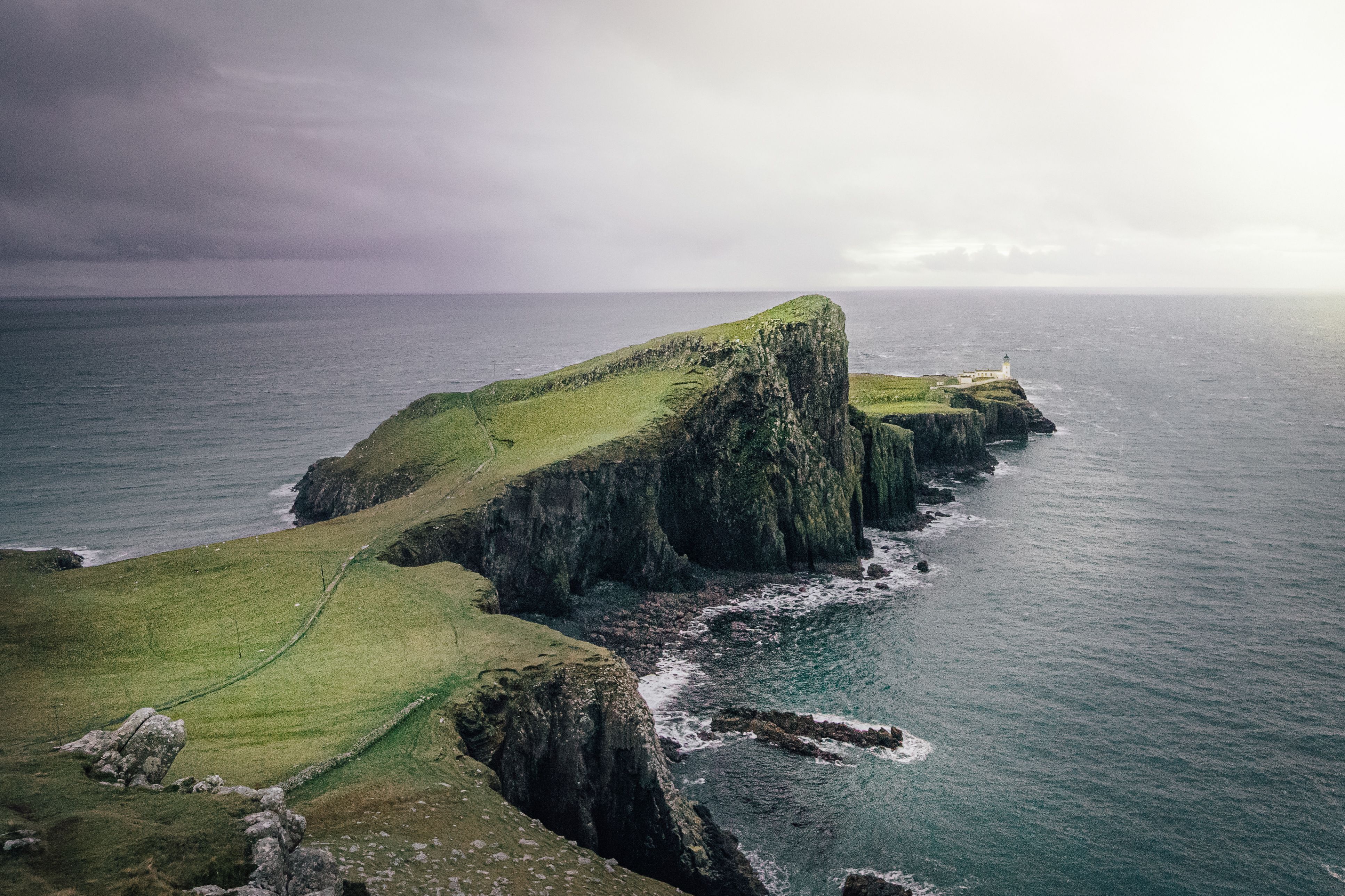 Gray Seascape and a Lighthouse on the Green Coast · Free Stock Photo