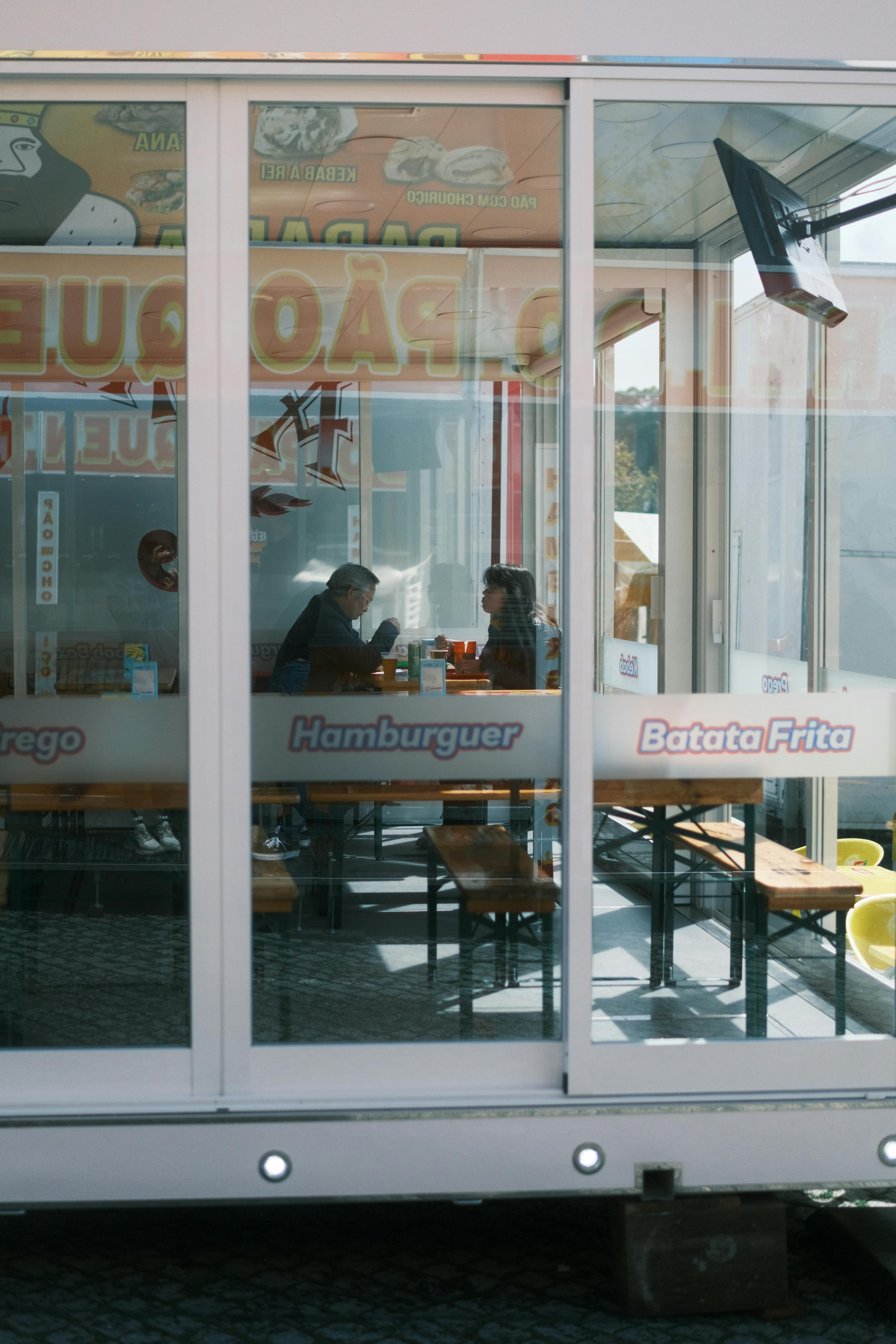 People Sitting and Eating at Food Bar · Free Stock Photo