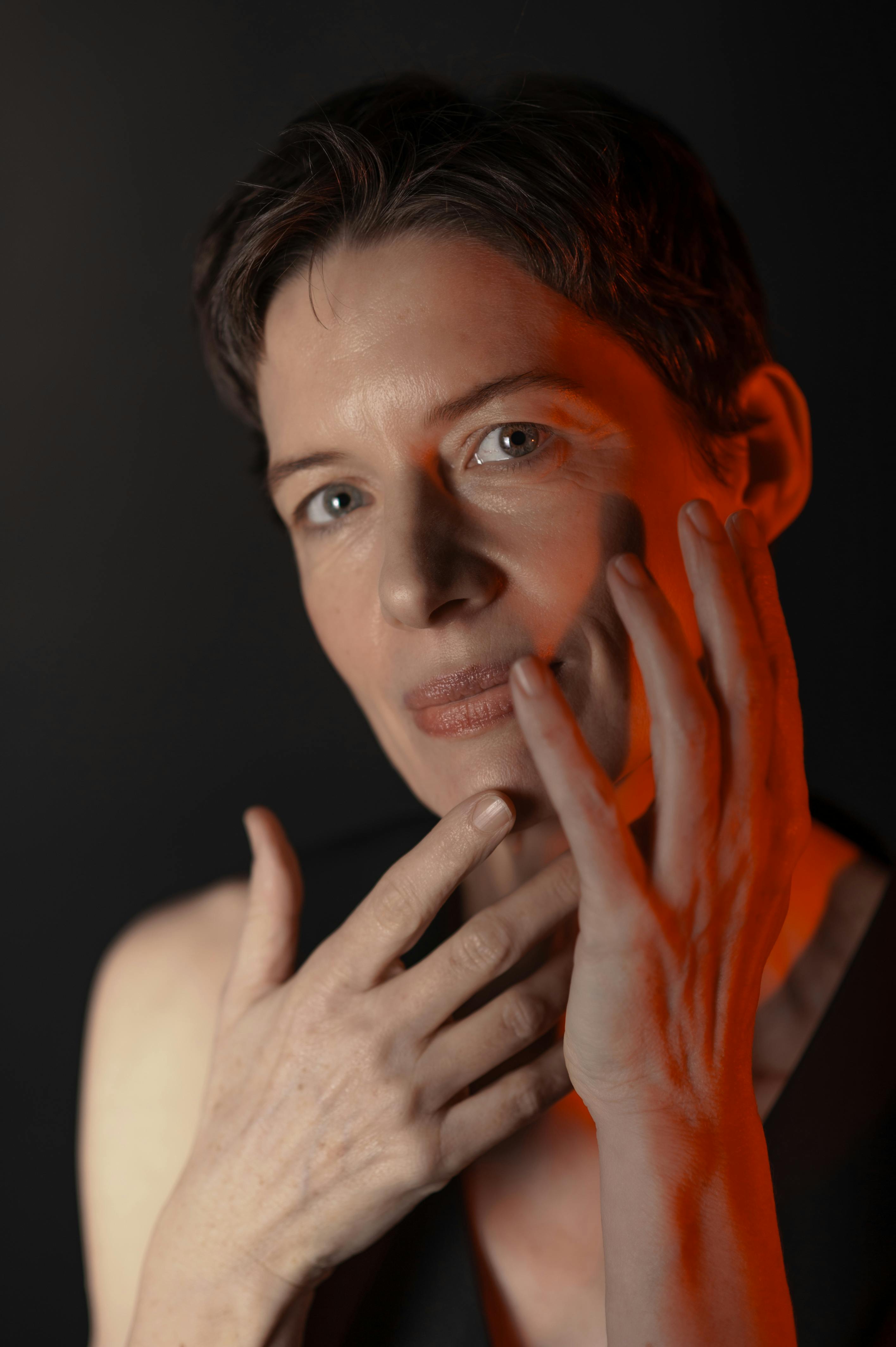 Portrait of Woman with Hands around Face · Free Stock Photo