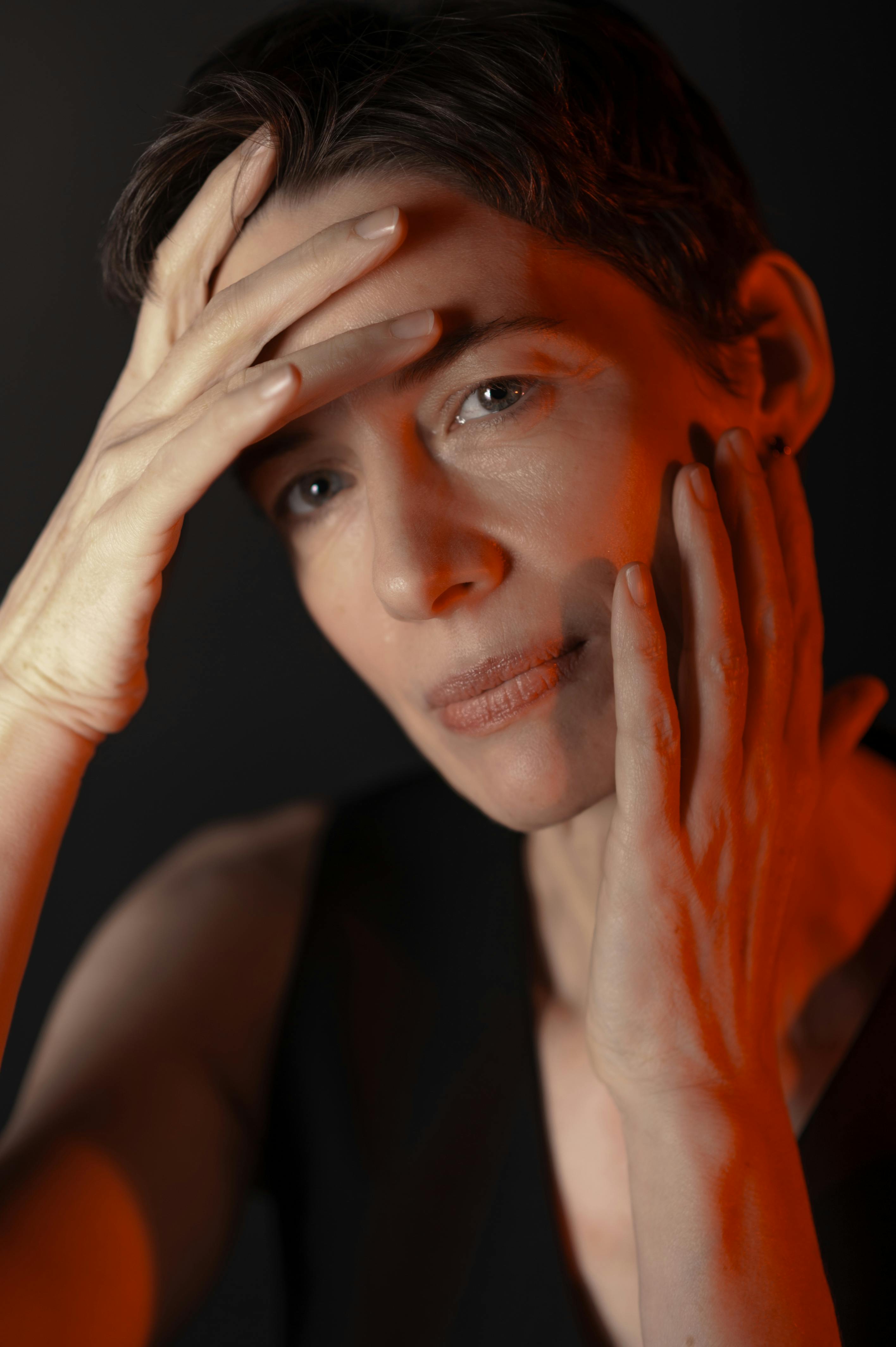 Portrait of Woman Holding Hands around Face · Free Stock Photo