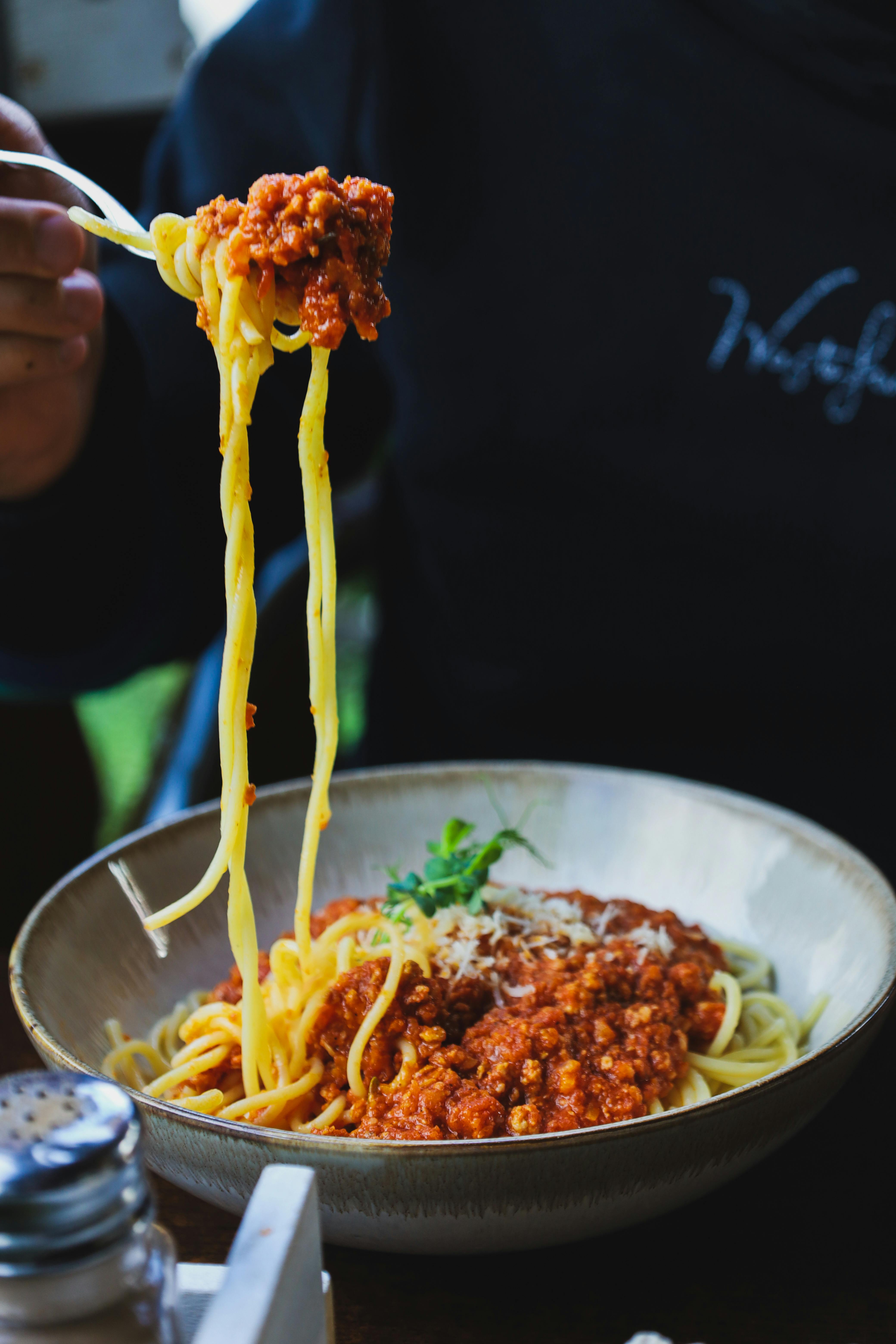 Close-up of a Person Eating Spaghetti Pasta Dish · Free Stock Photo