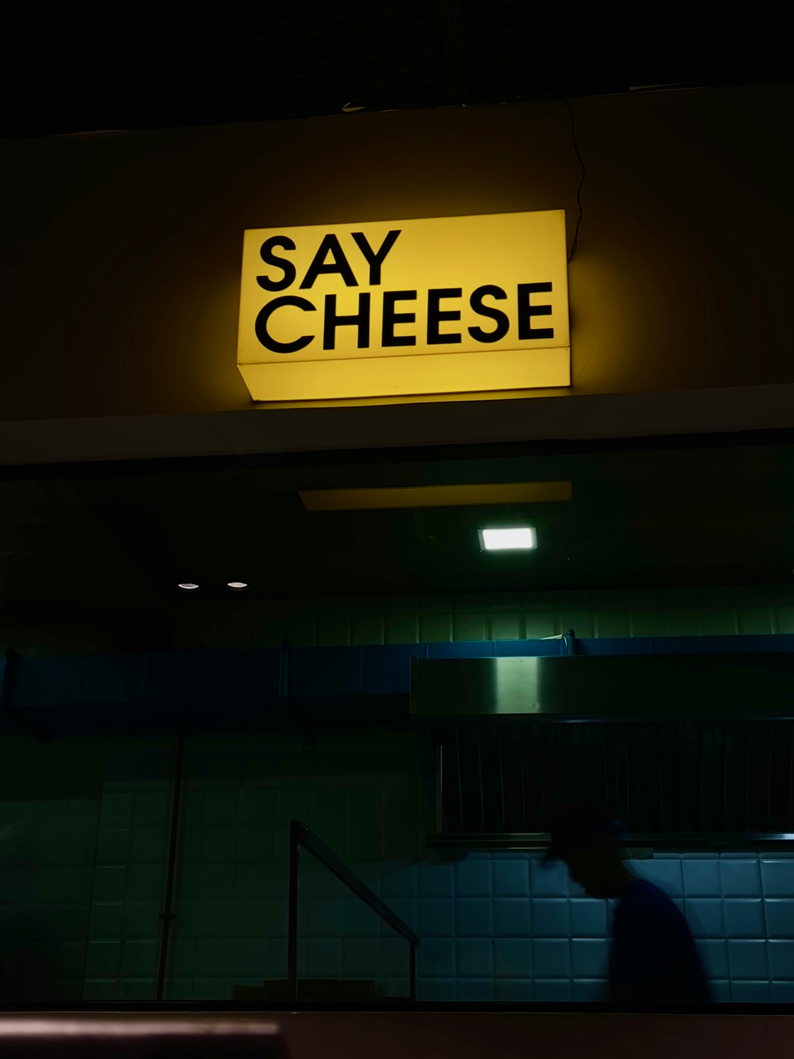 Say Cheese Text on Wall in Darkness · Free Stock Photo
