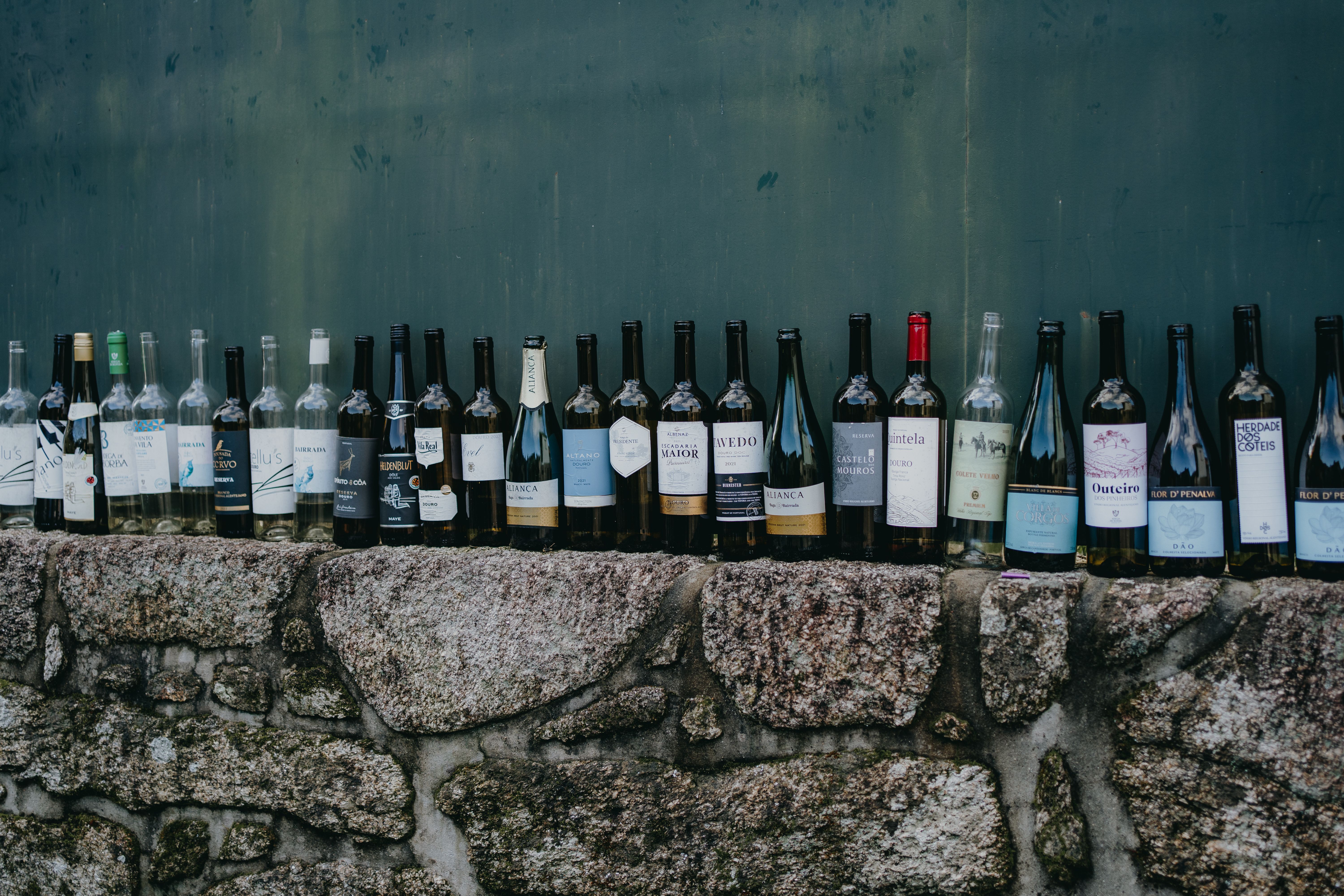 Row of Bottles of Wine on Wall · Free Stock Photo