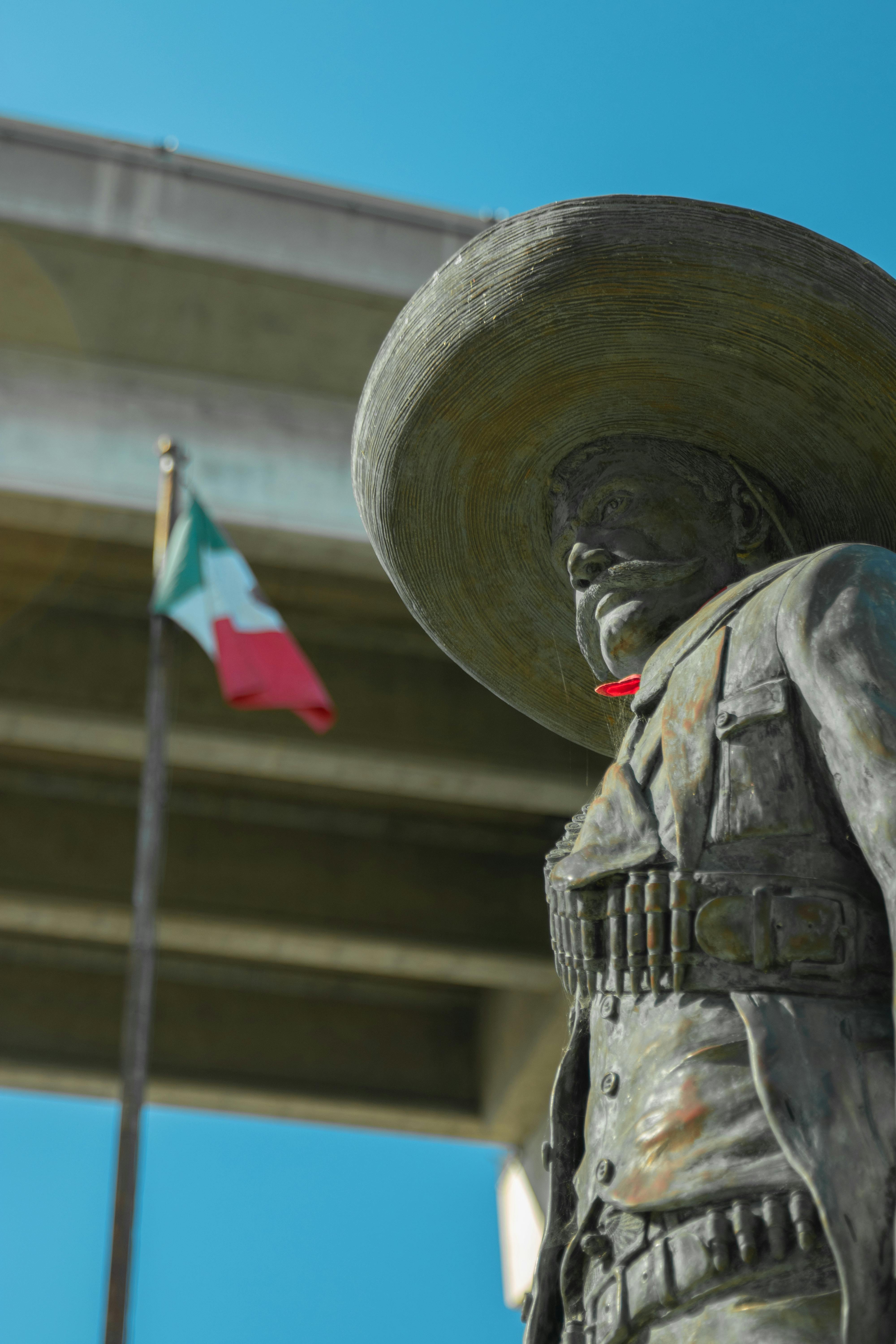 Statue of Emiliano Zapata under Mexican Flag · Free Stock Photo