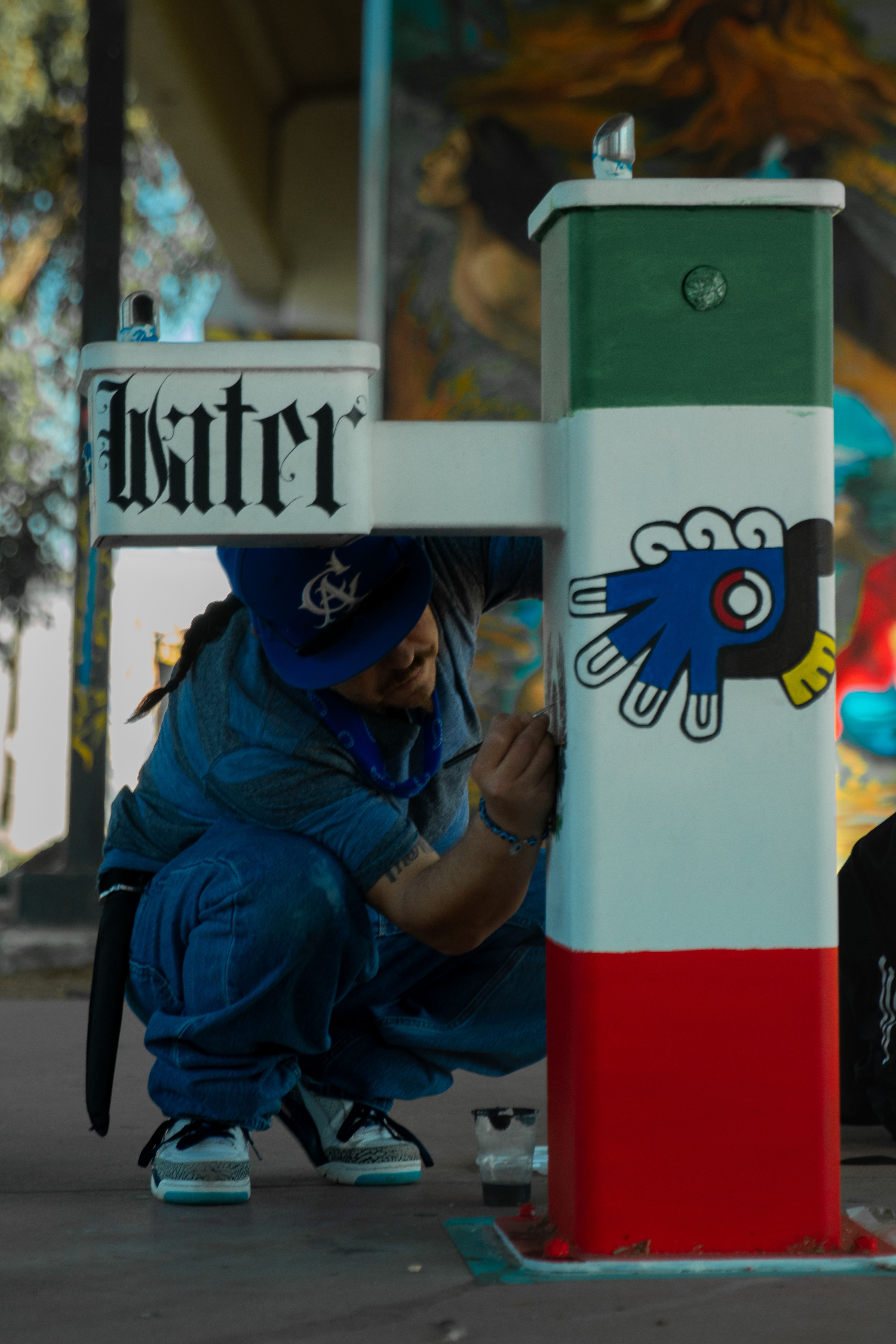 Crouching Man Painting Water Fountain · Free Stock Photo