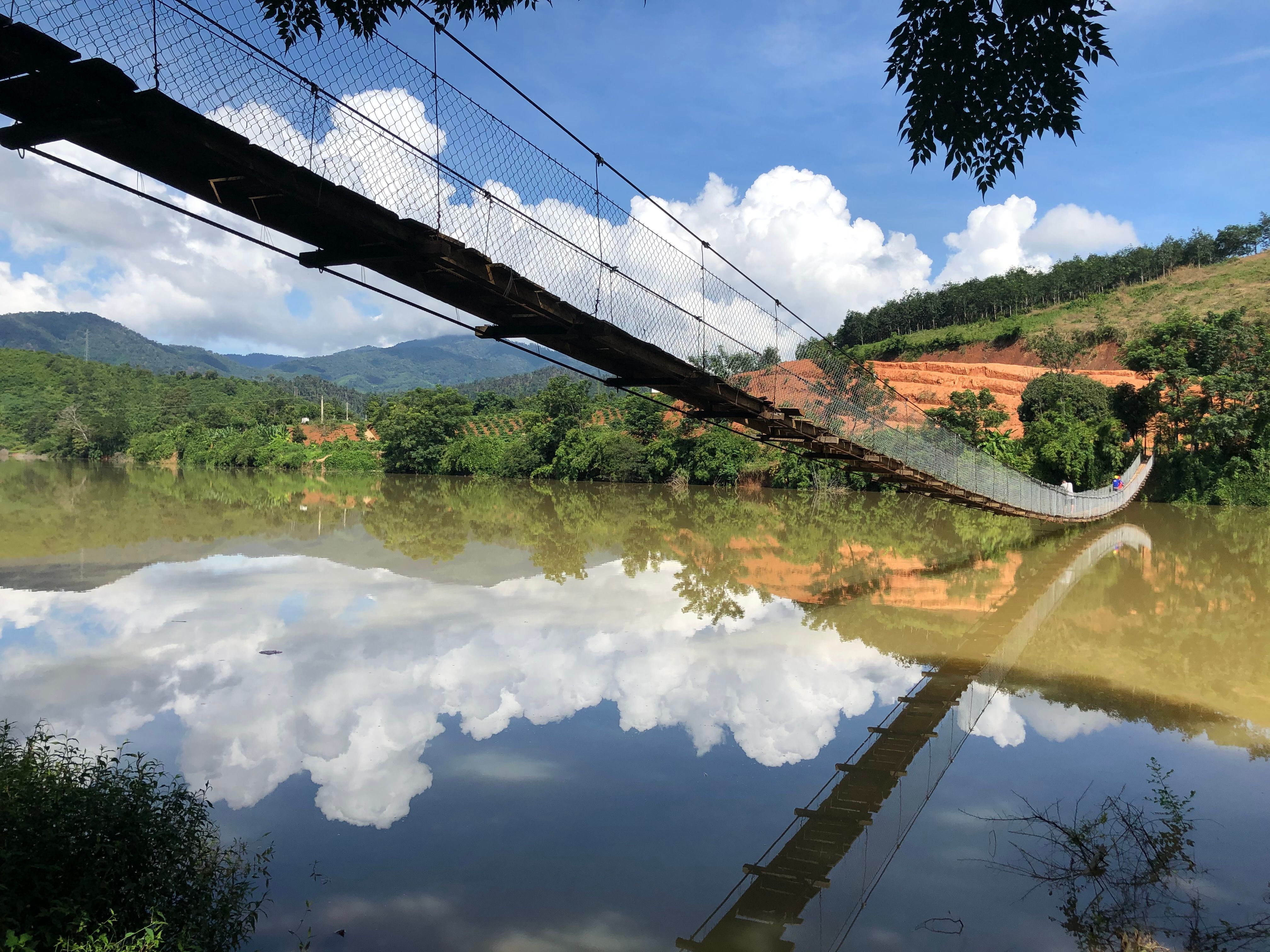 Suspension Bridge above Reflective Lake Surface · Free Stock Photo