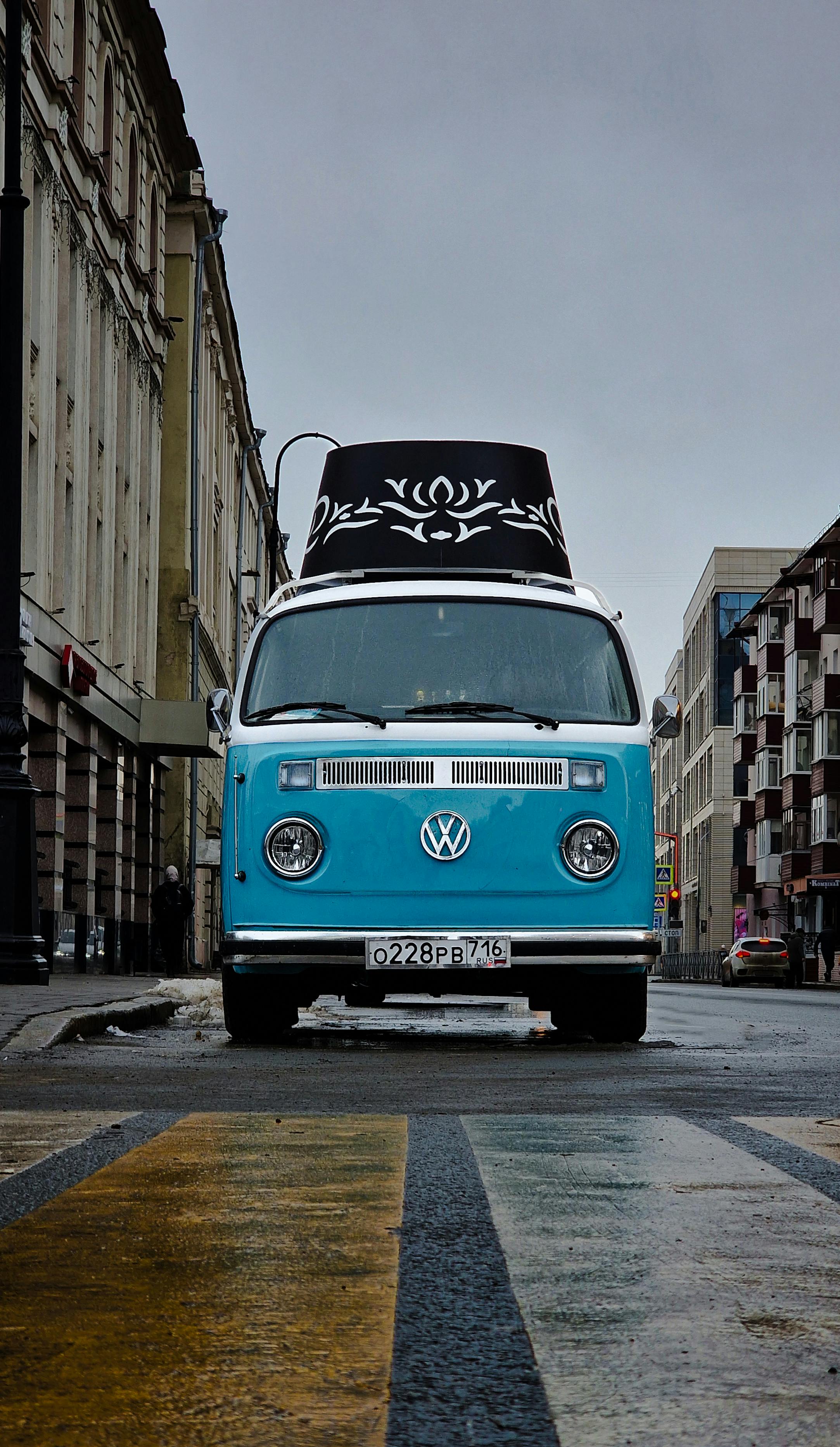 A blue vw bus with a sign on it · Free Stock Photo
