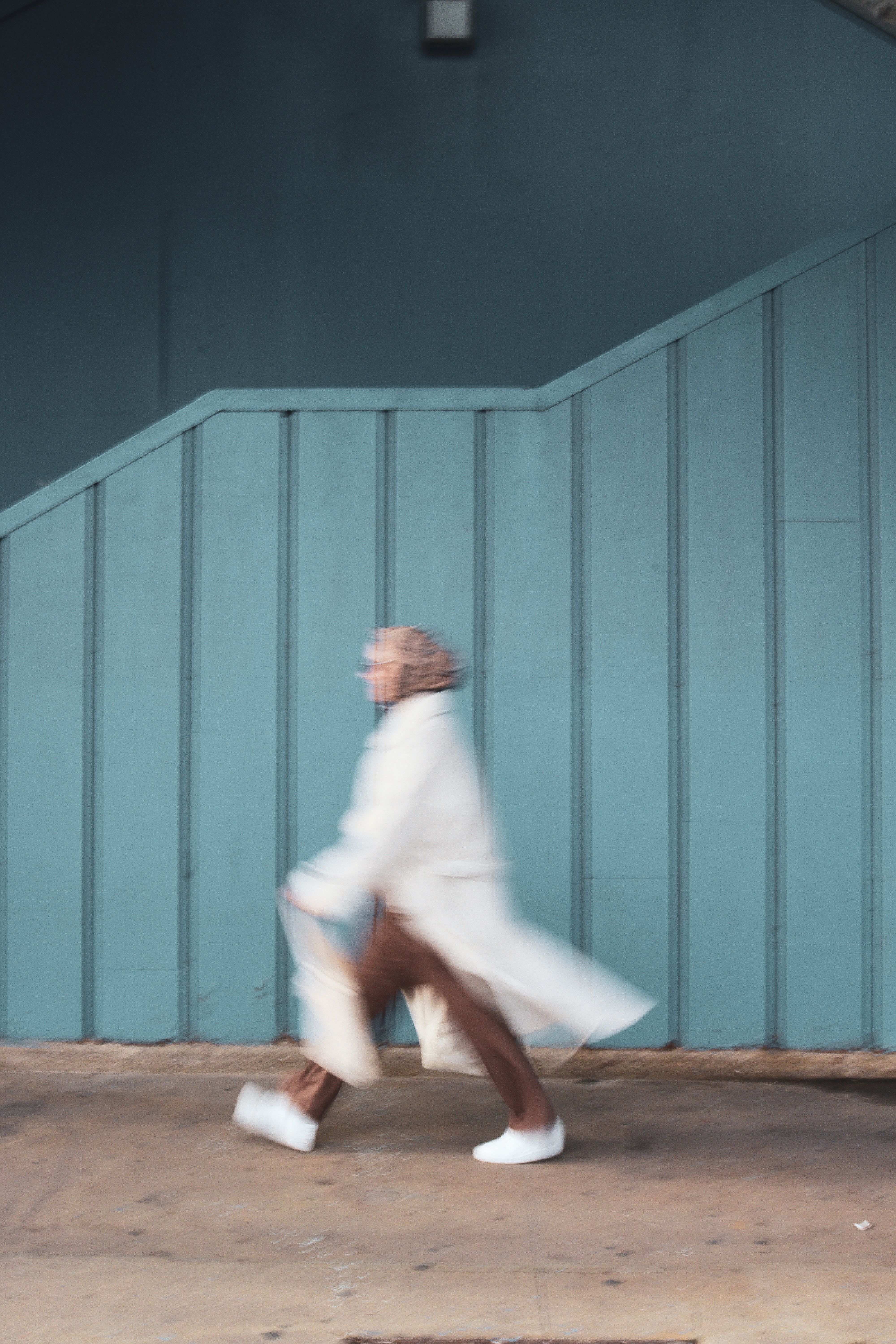 Side View of a Woman Walking on a Sidewalk · Free Stock Photo