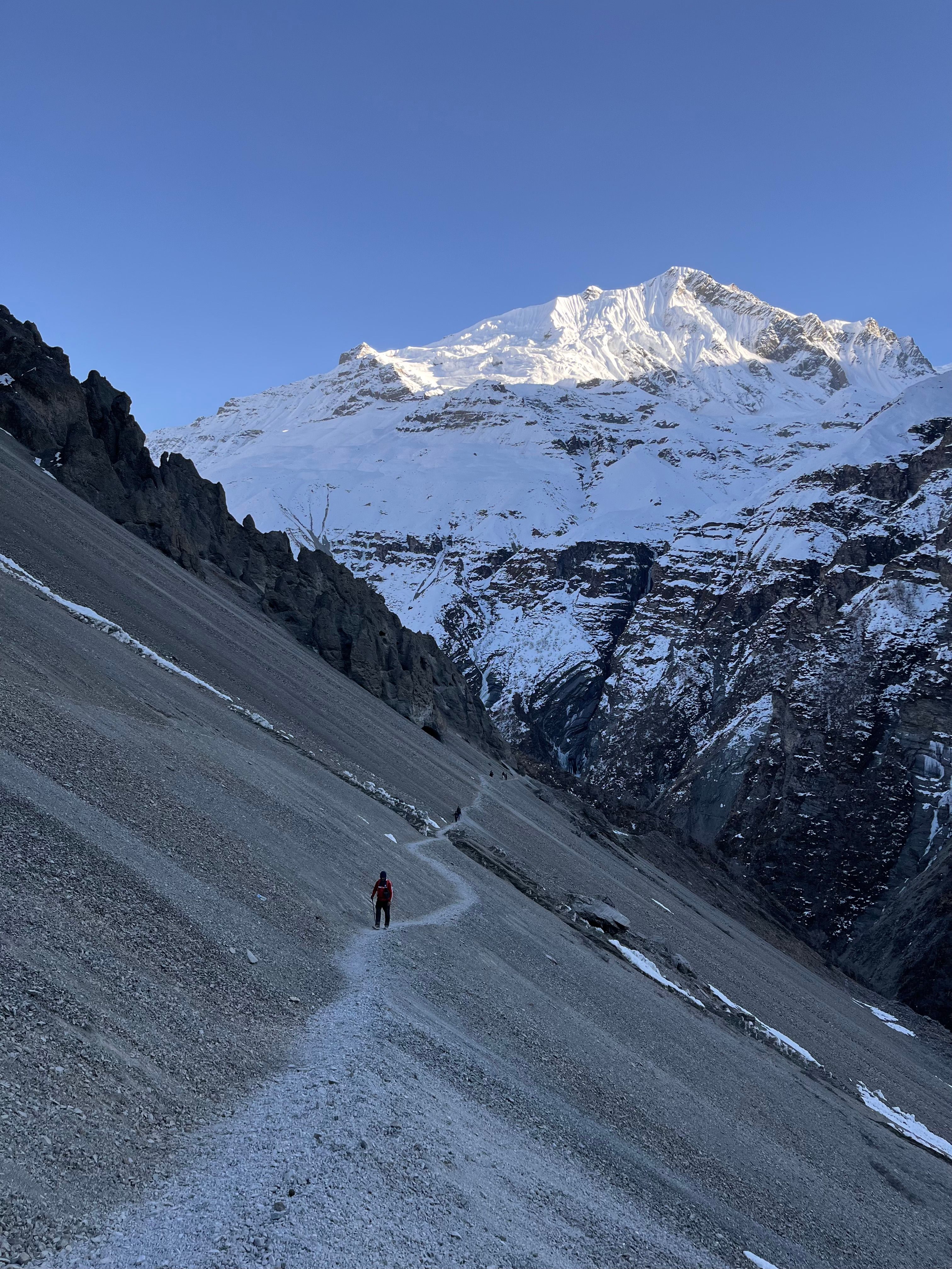 Person Walking on Footpath on Slope in Mountains · Free Stock Photo
