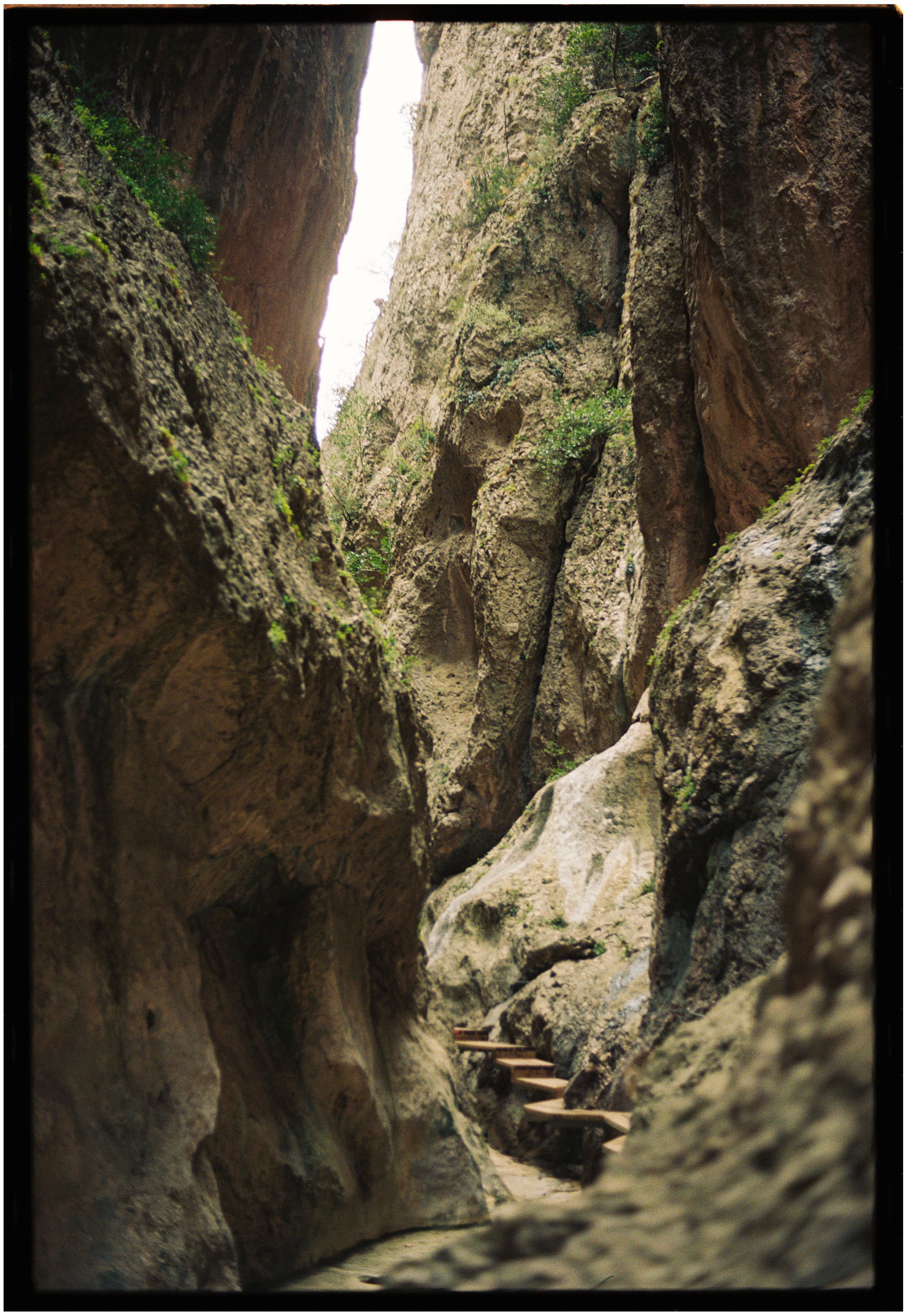 A photo of a narrow canyon with a wooden bridge · Free Stock Photo