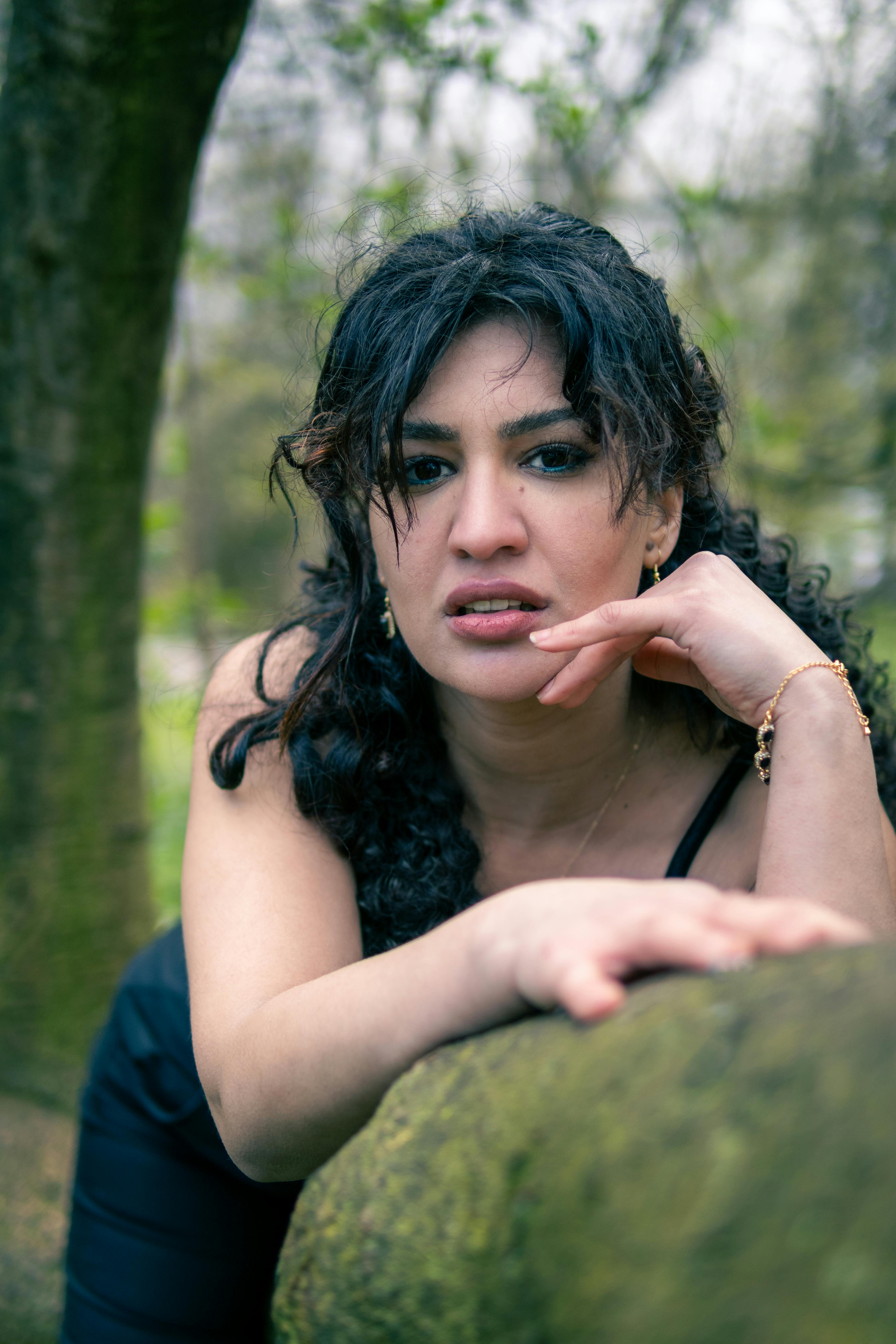 Brunette Woman Bending on Rock · Free Stock Photo