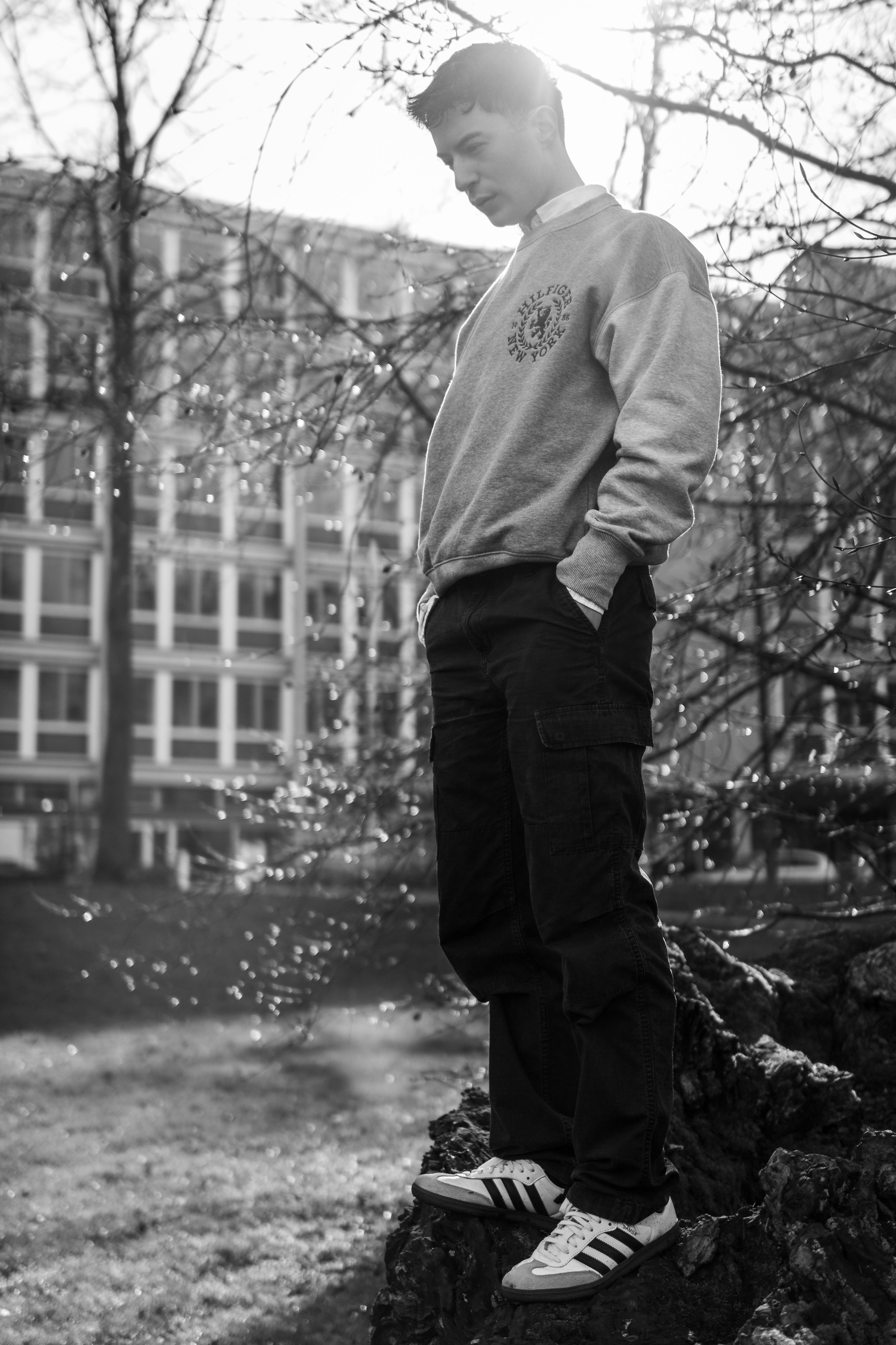 Man Standing on Rocks with Hands in Pockets · Free Stock Photo