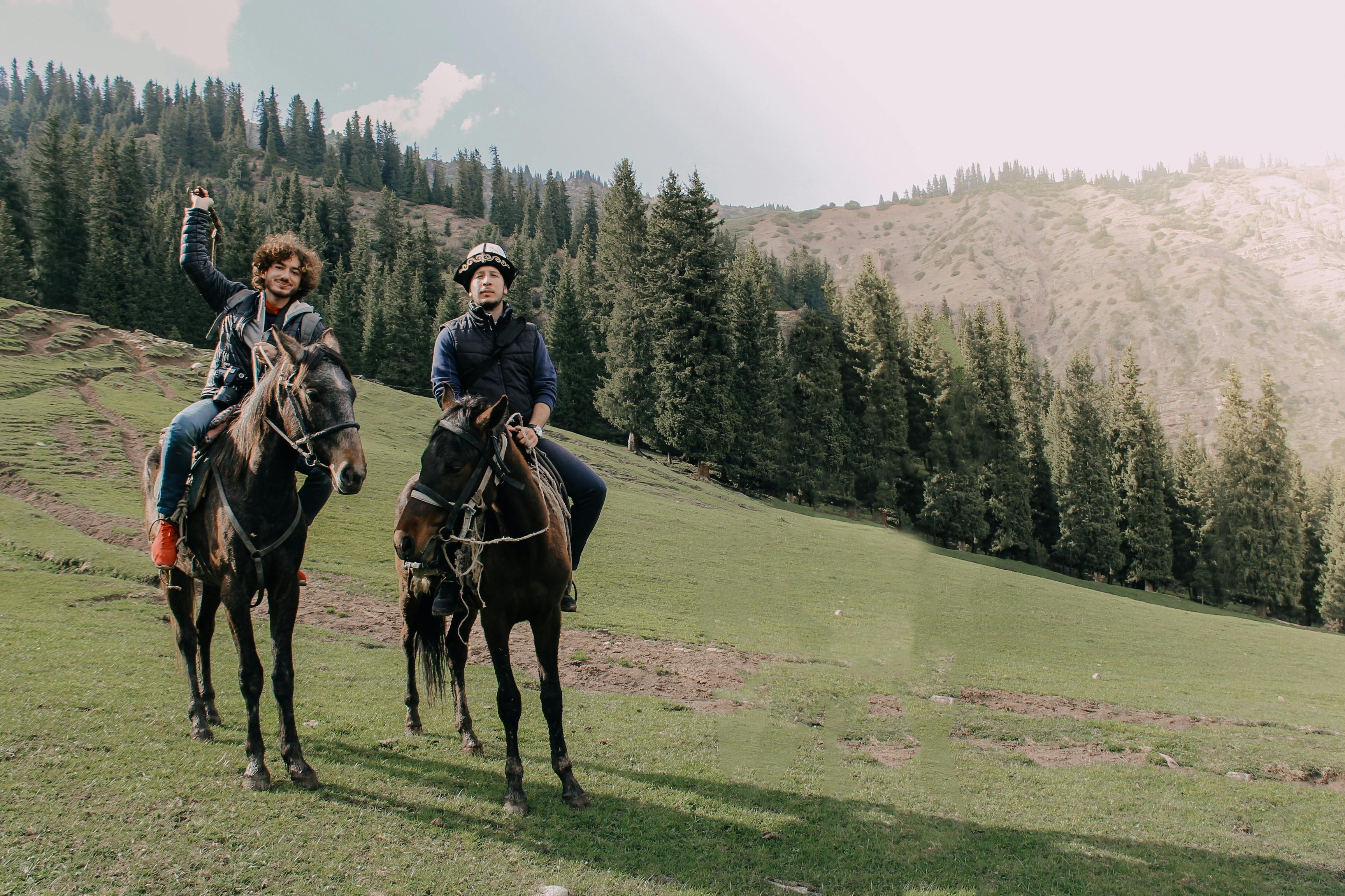 Two people riding horses in the mountains · Free Stock Photo