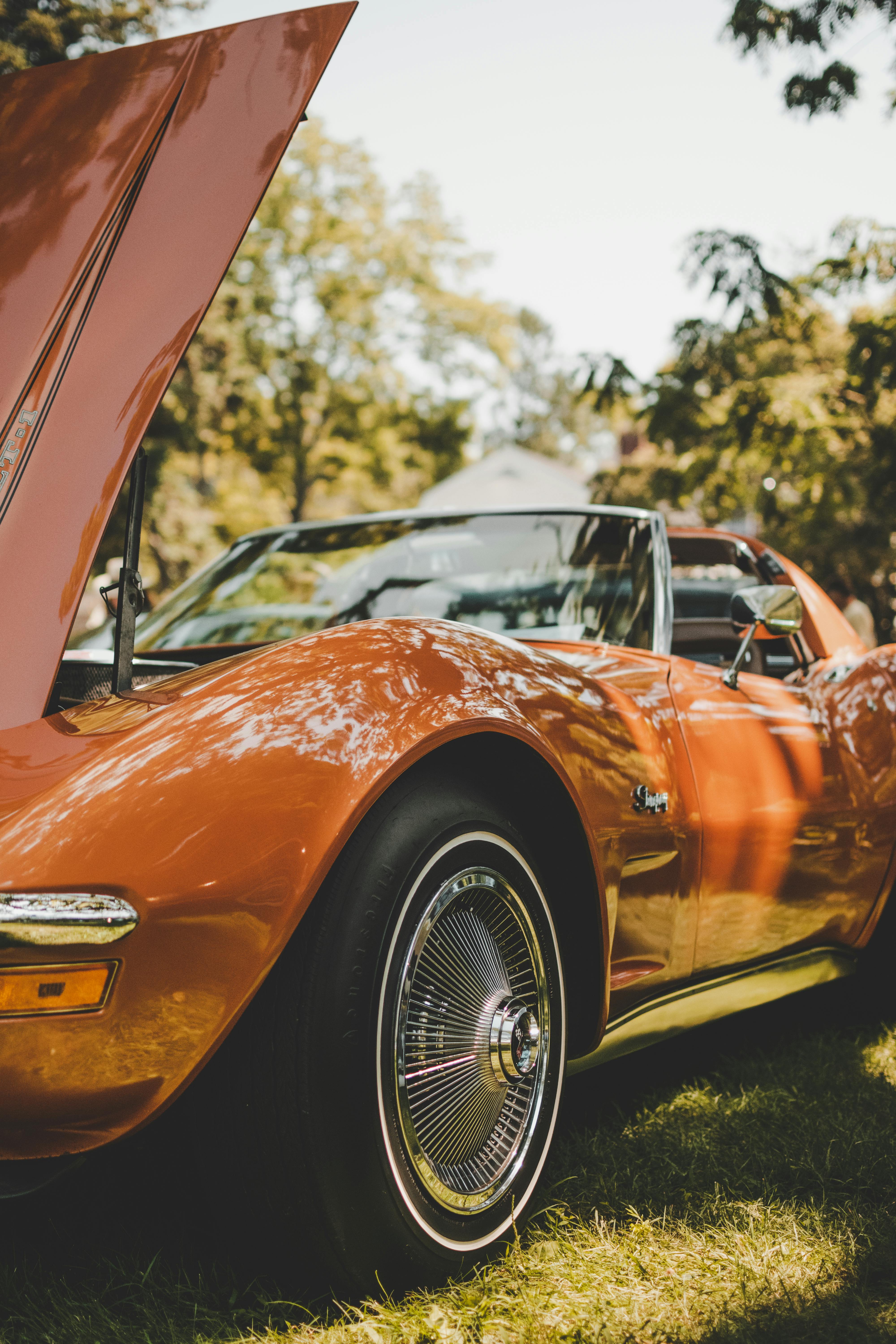 Vintage Orange Car Standing on the Grass · Free Stock Photo