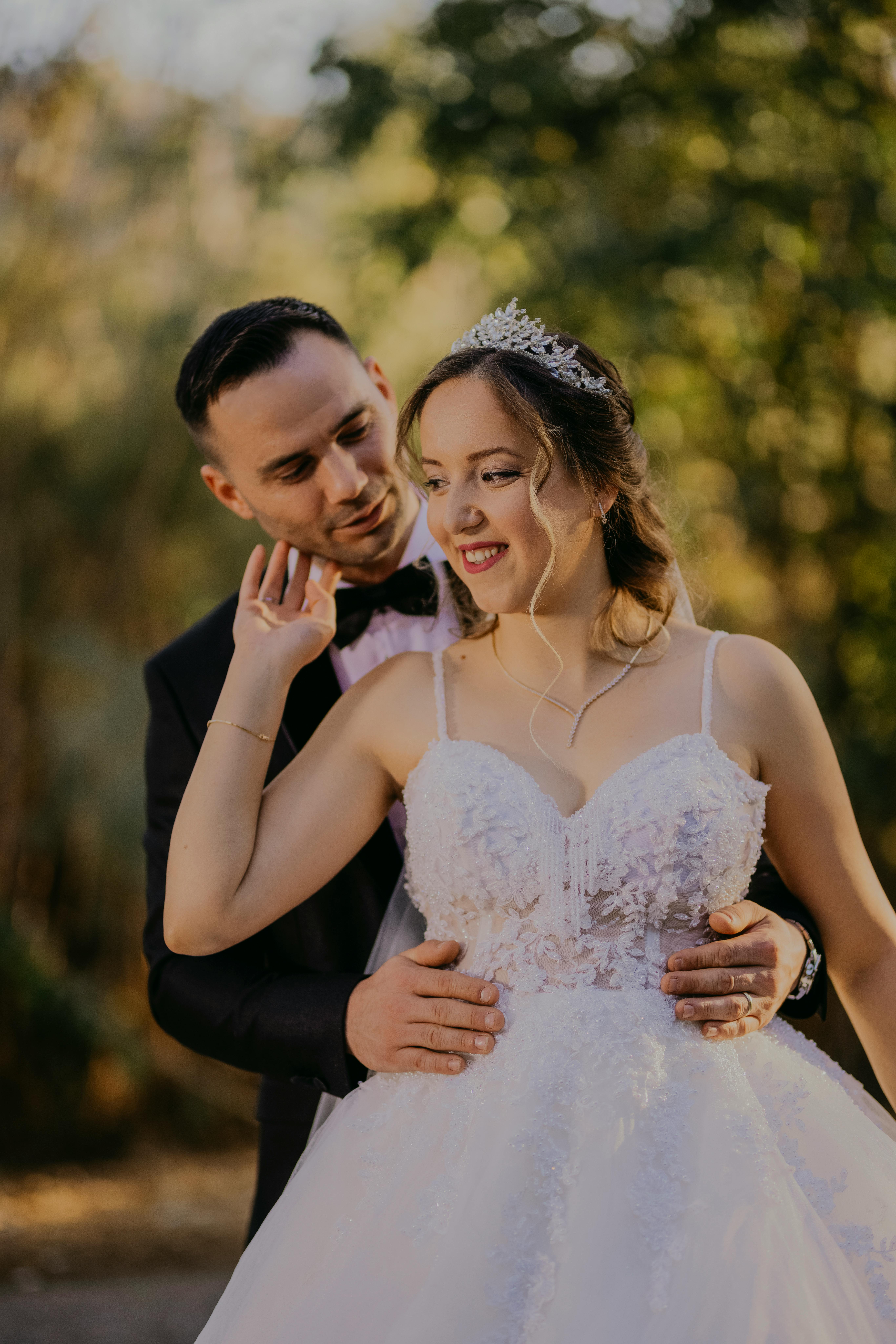 Groom Romantically Holding Bride from Behind · Free Stock Photo