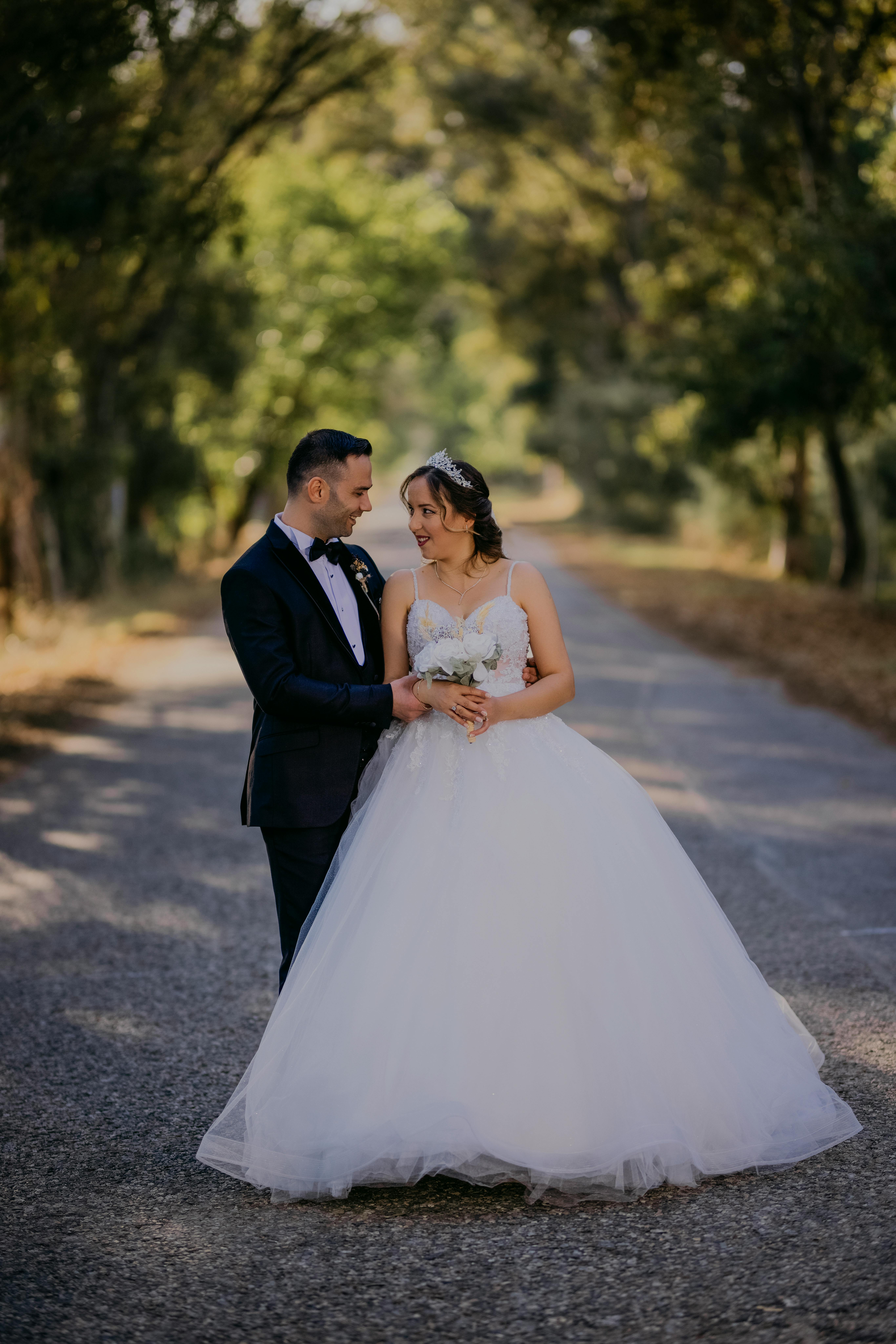 Groom Holding a Bride on a Path in the Park · Free Stock Photo