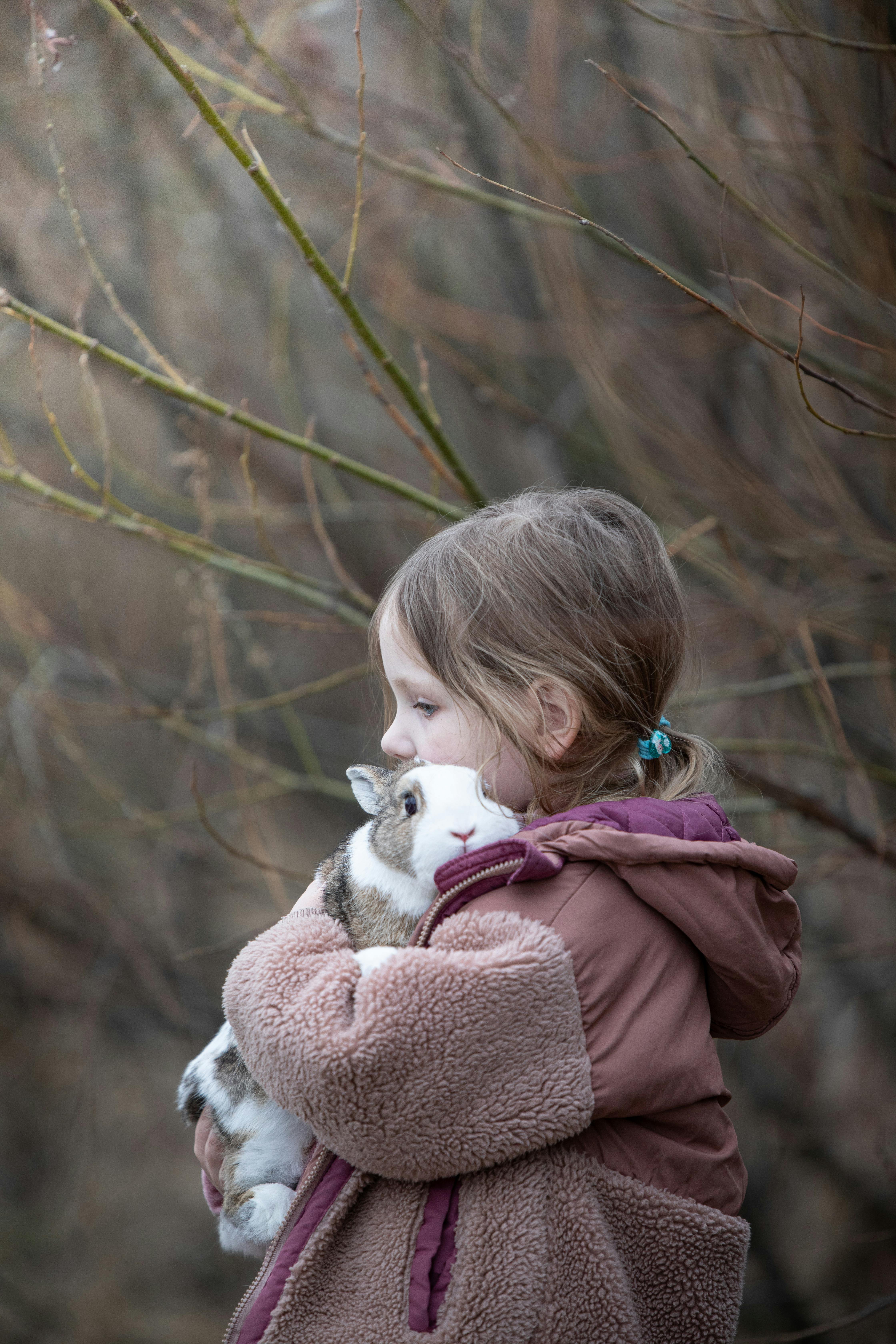 Little Girl Hugging Adorable Bunny · Free Stock Photo