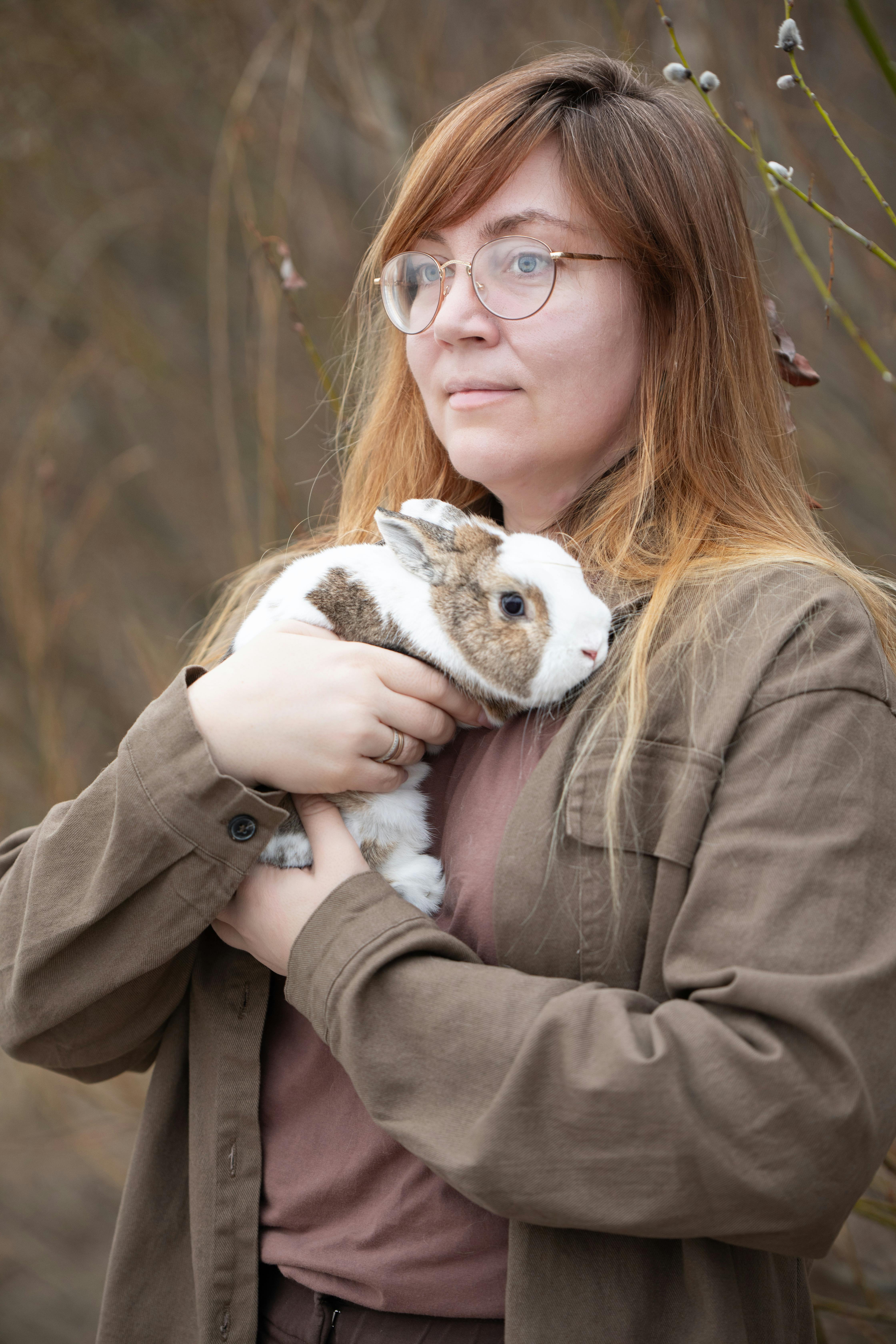 Woman in Glasses Posing with a Rabbit in Her Arms · Free Stock Photo