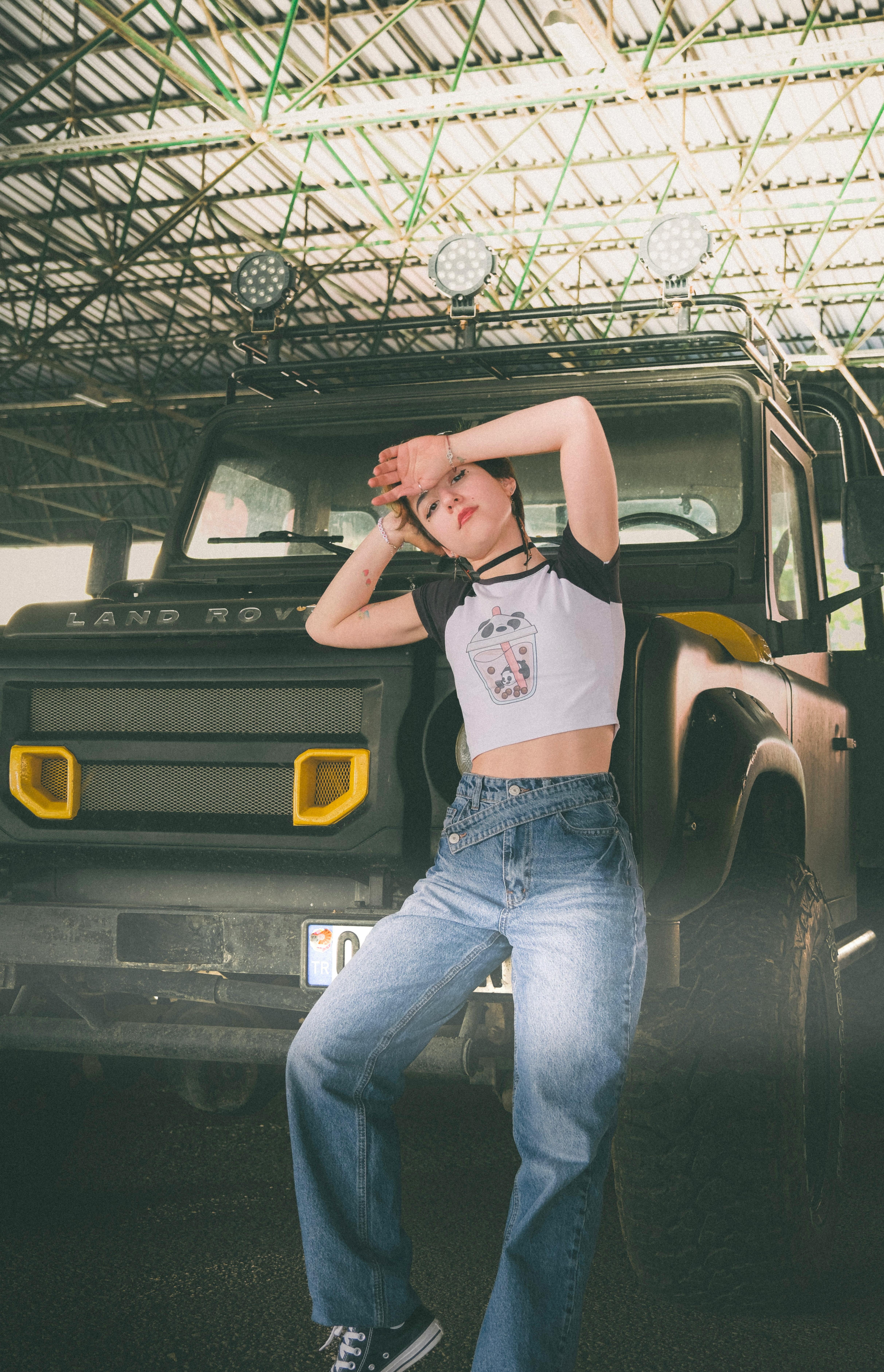 Woman in T-shirt Posing by Land Rover Car · Free Stock Photo