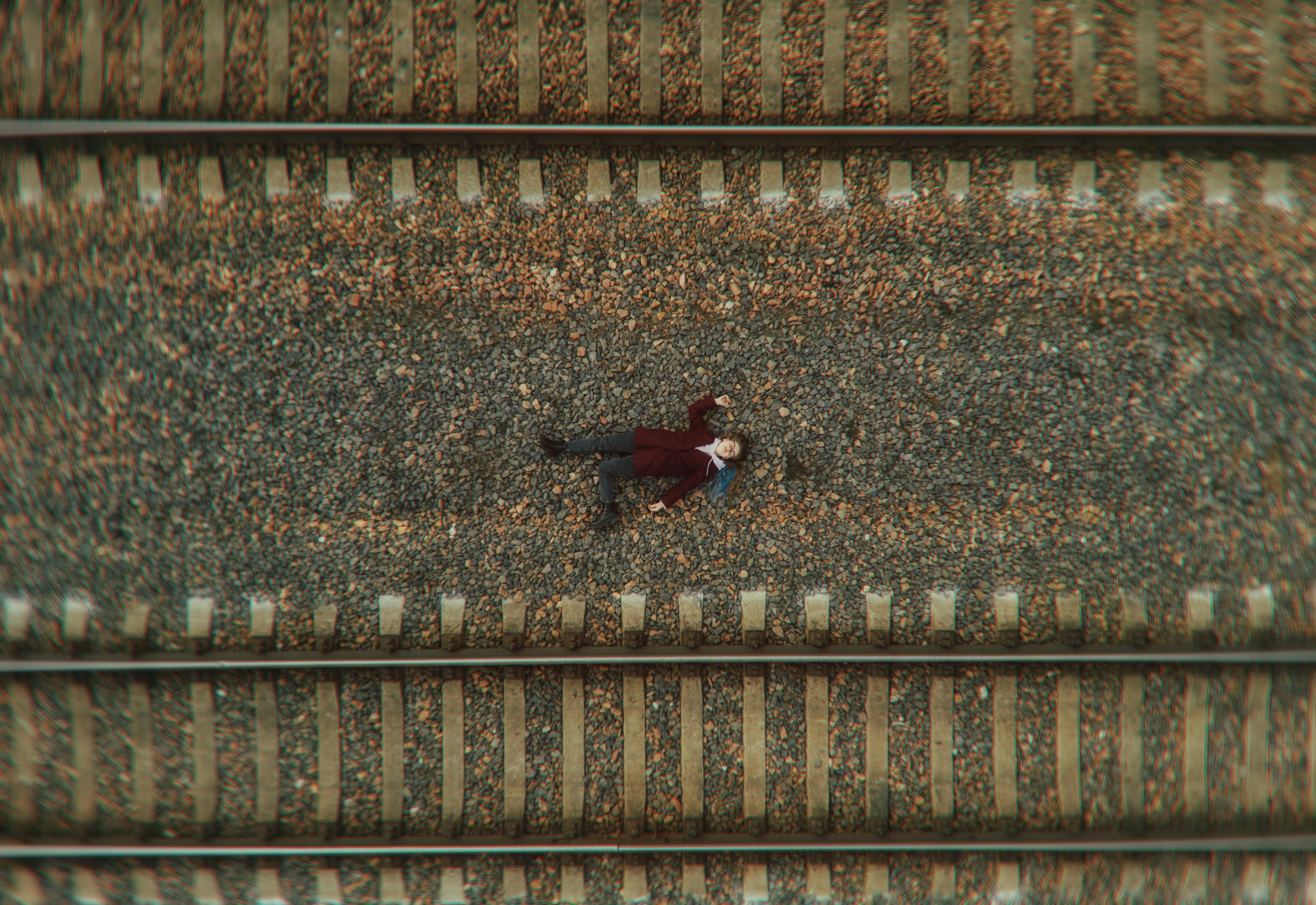 A person walking on the railroad tracks · Free Stock Photo