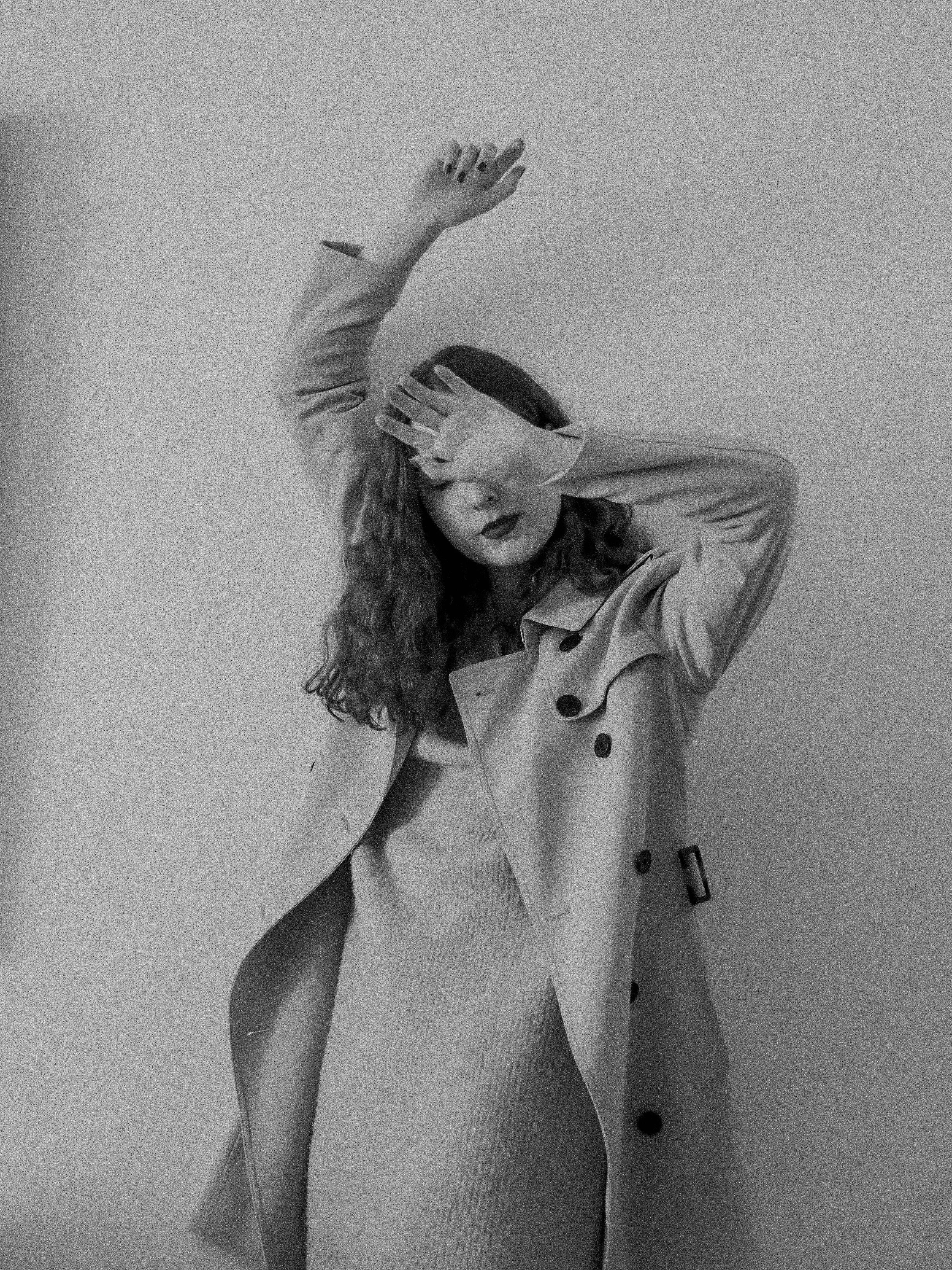 Woman in Coat Posing with Raised Hands · Free Stock Photo