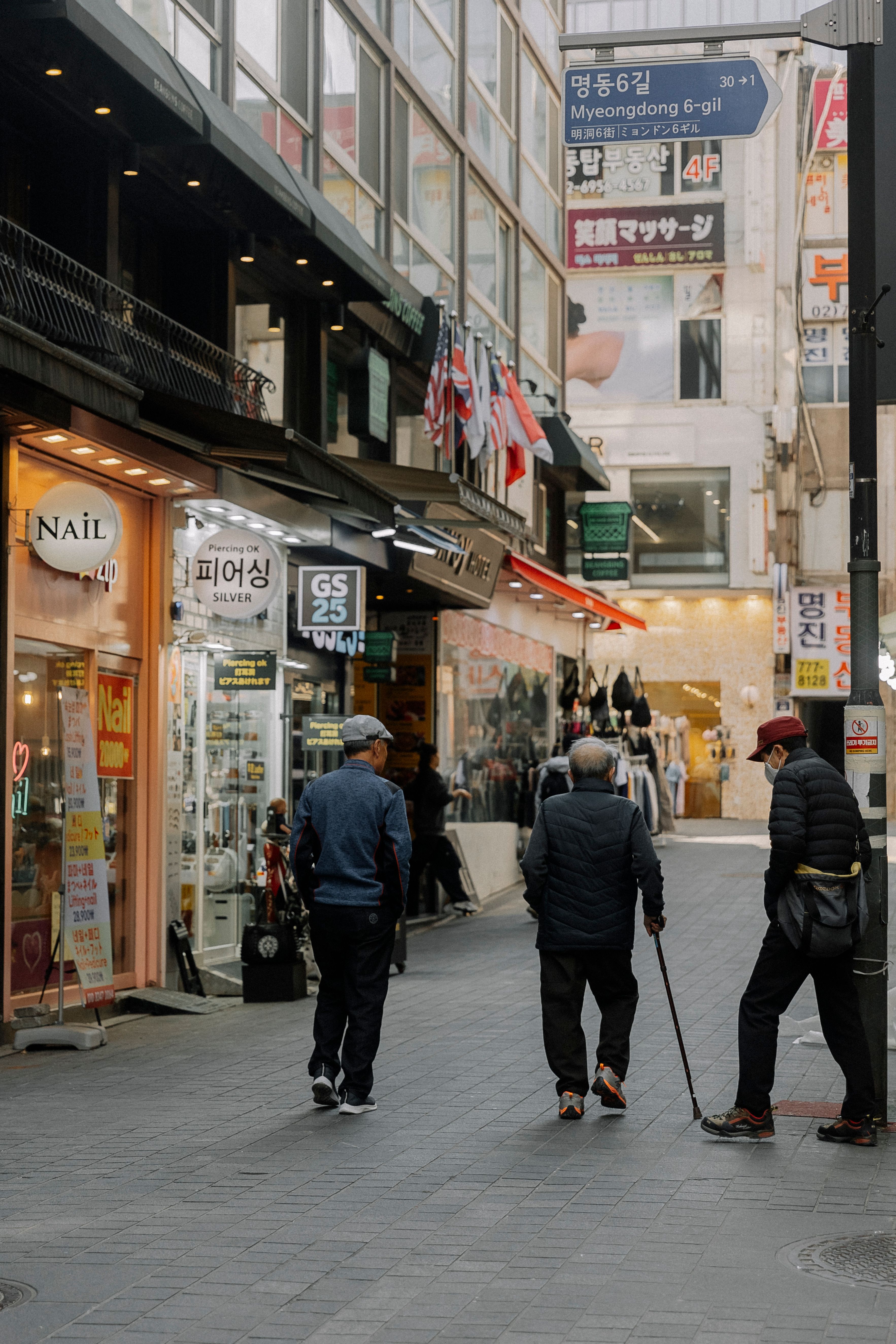 People Walking past a Row of Stores in an Alley · Free Stock Photo