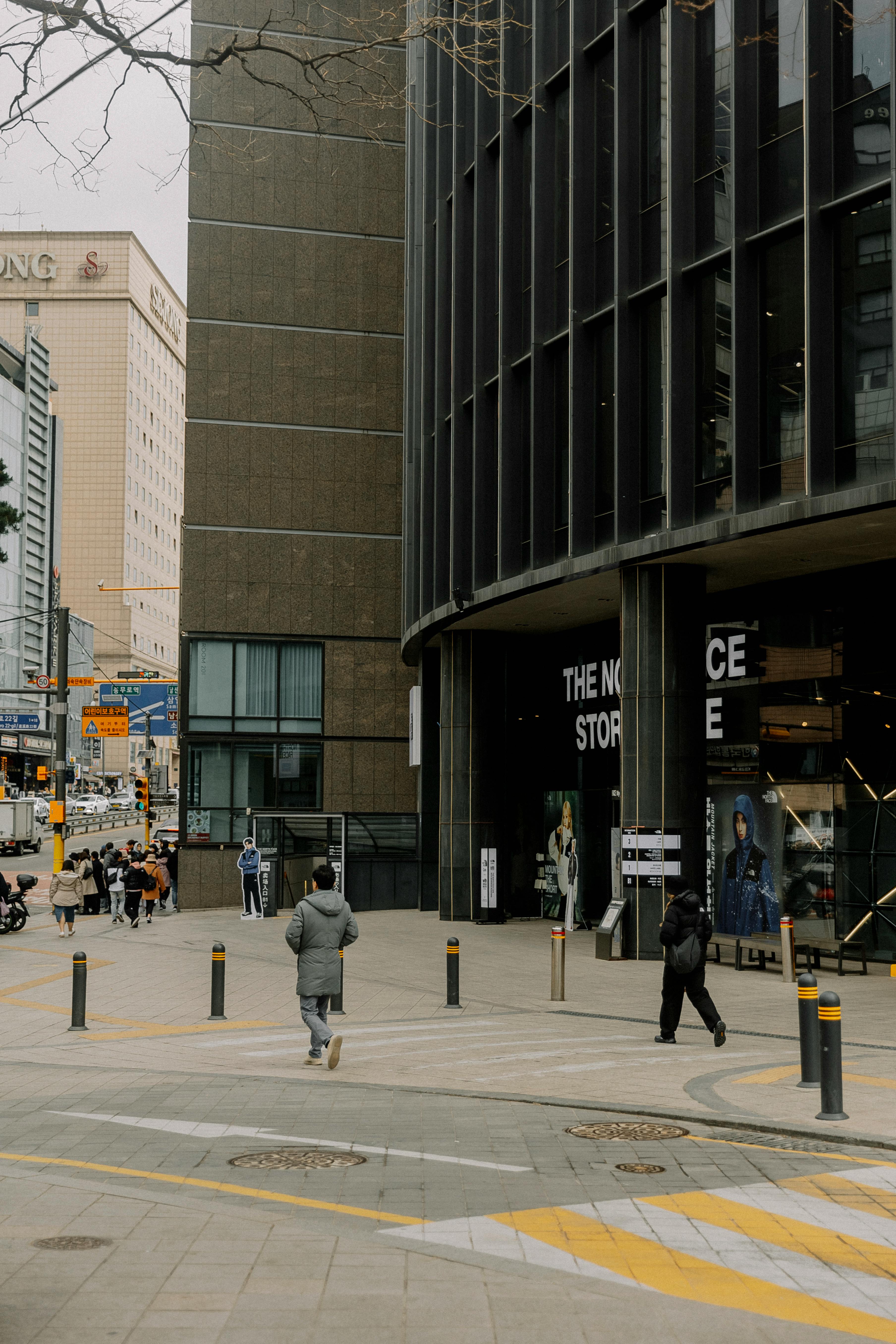 A person walking down a city street with buildings in the background ...