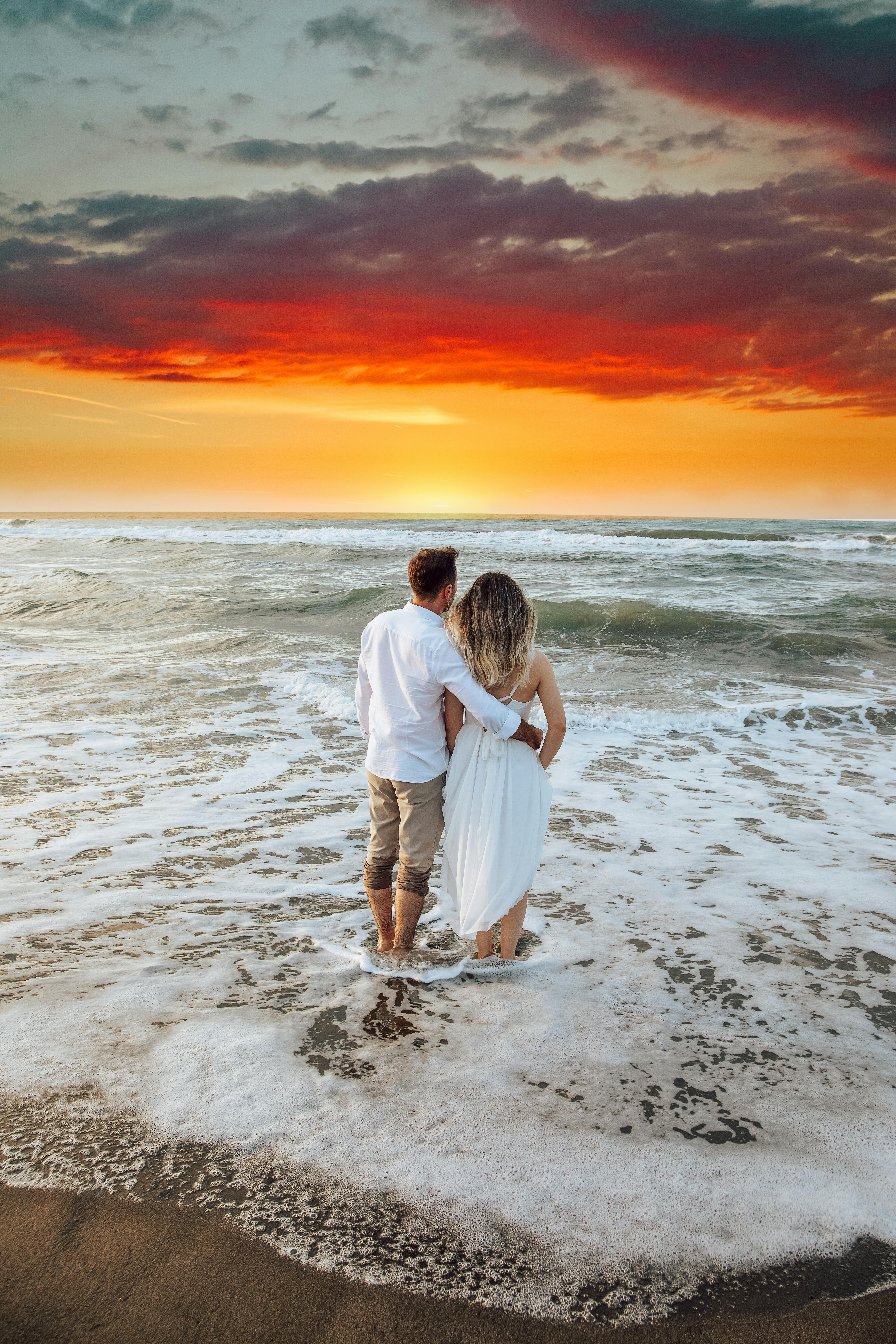 Couple by the Sea During Sunset · Free Stock Photo