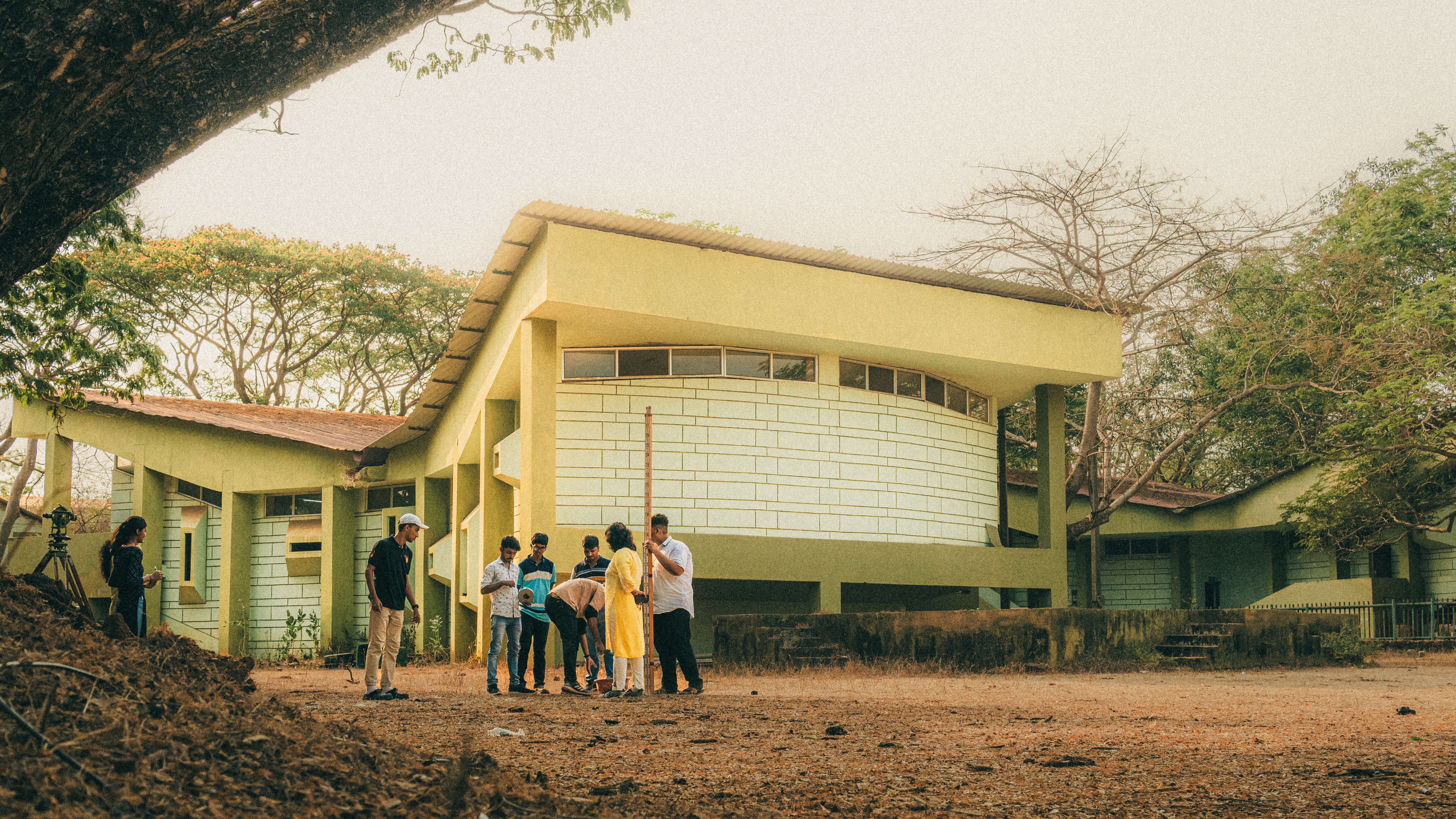 A group of people standing outside of a building · Free Stock Photo