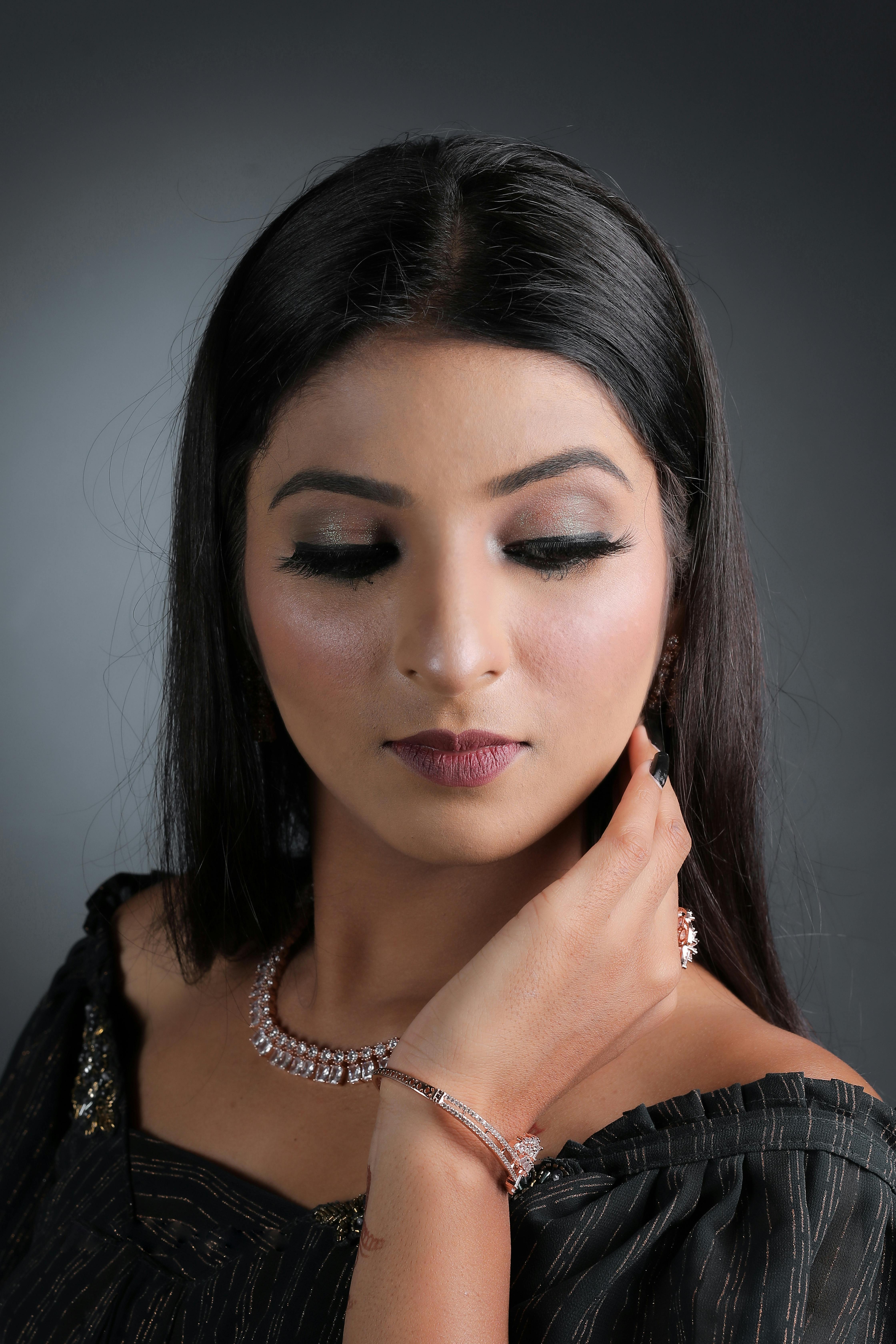 Portrait of a Woman Wearing Diamond Jewelry · Free Stock Photo