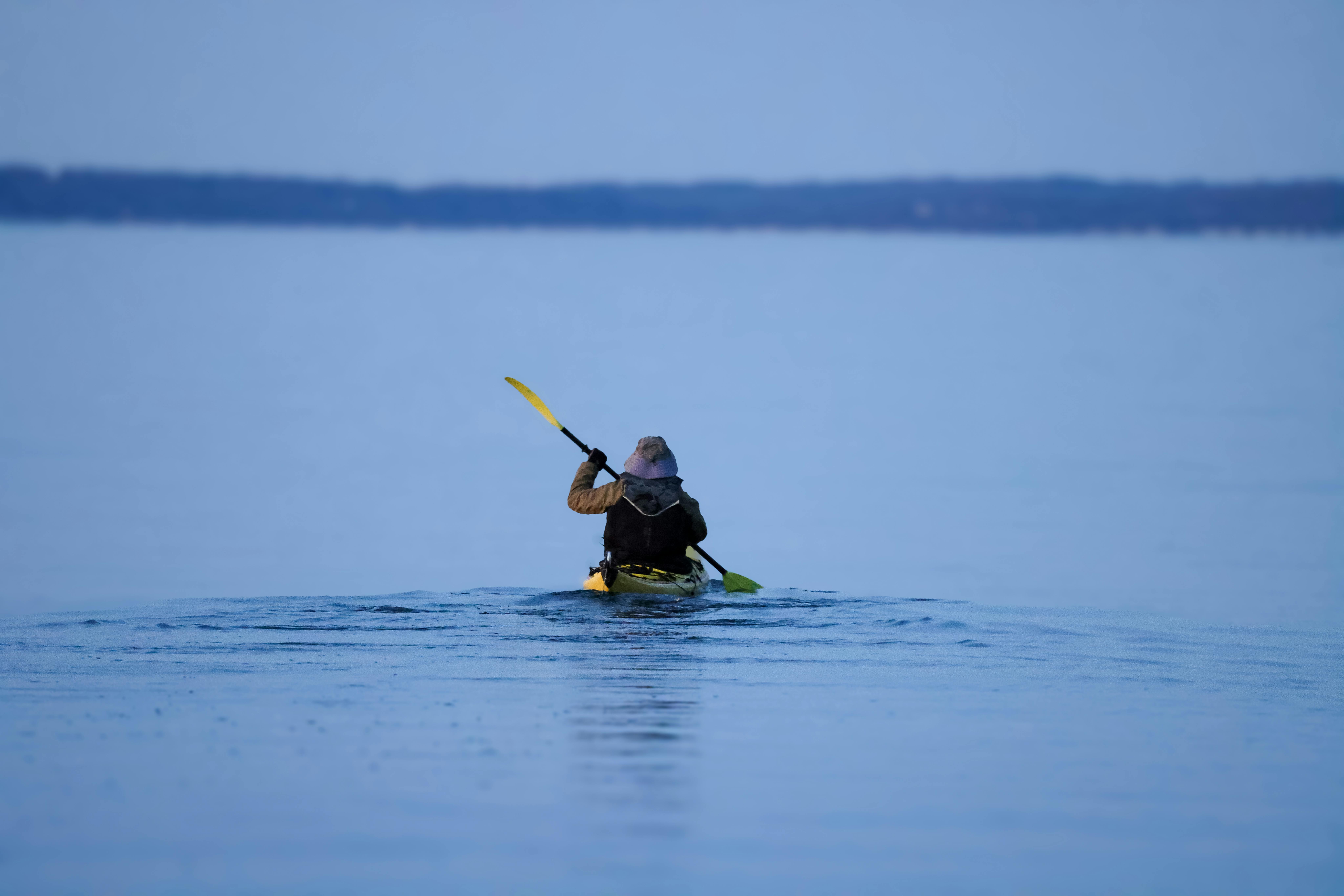 Back View of Person Canoeing on Lake · Free Stock Photo