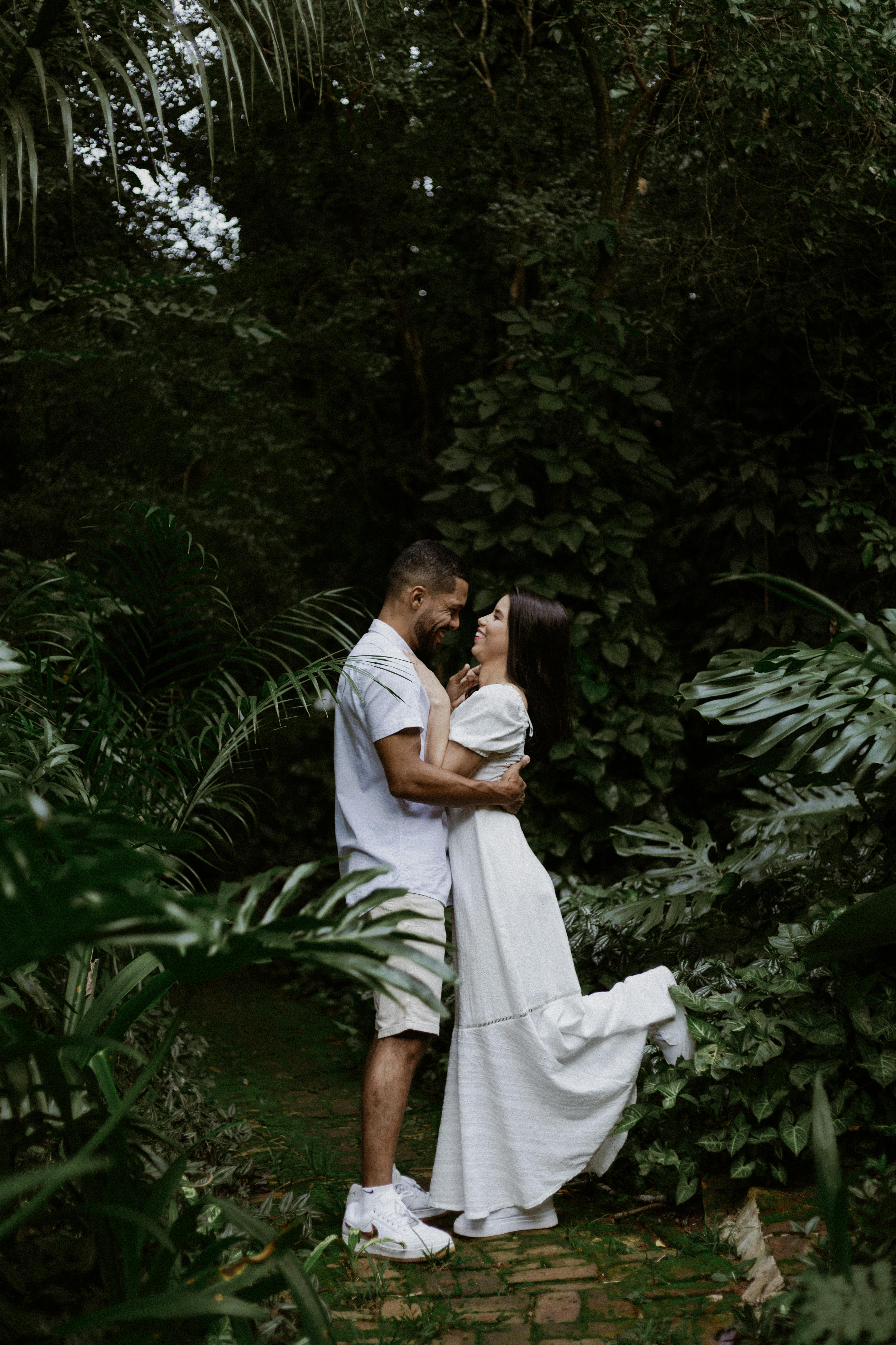 Lovely Couple Hugging against Foliage Background · Free Stock Photo