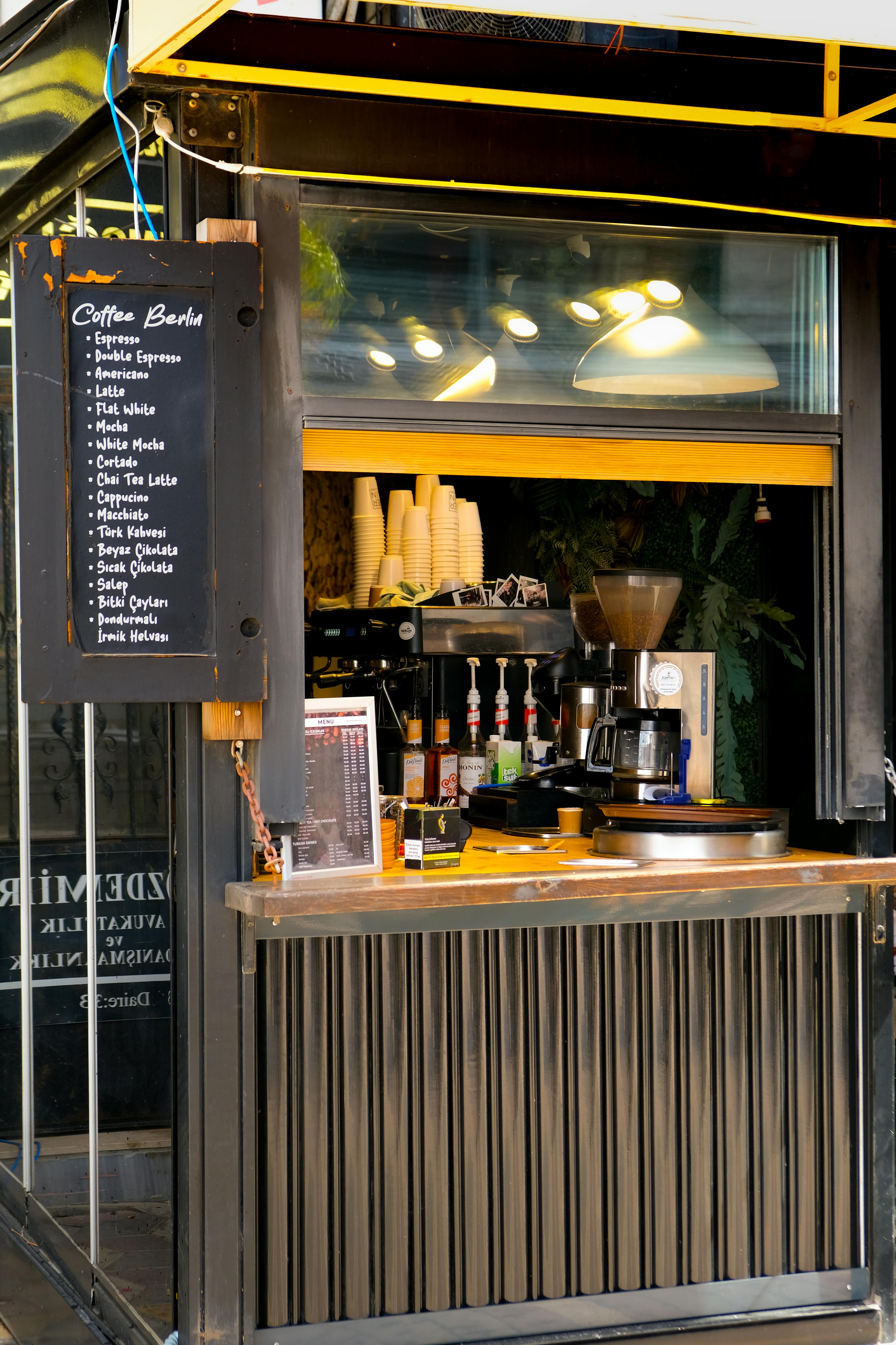 A small food stand with a menu on the side · Free Stock Photo