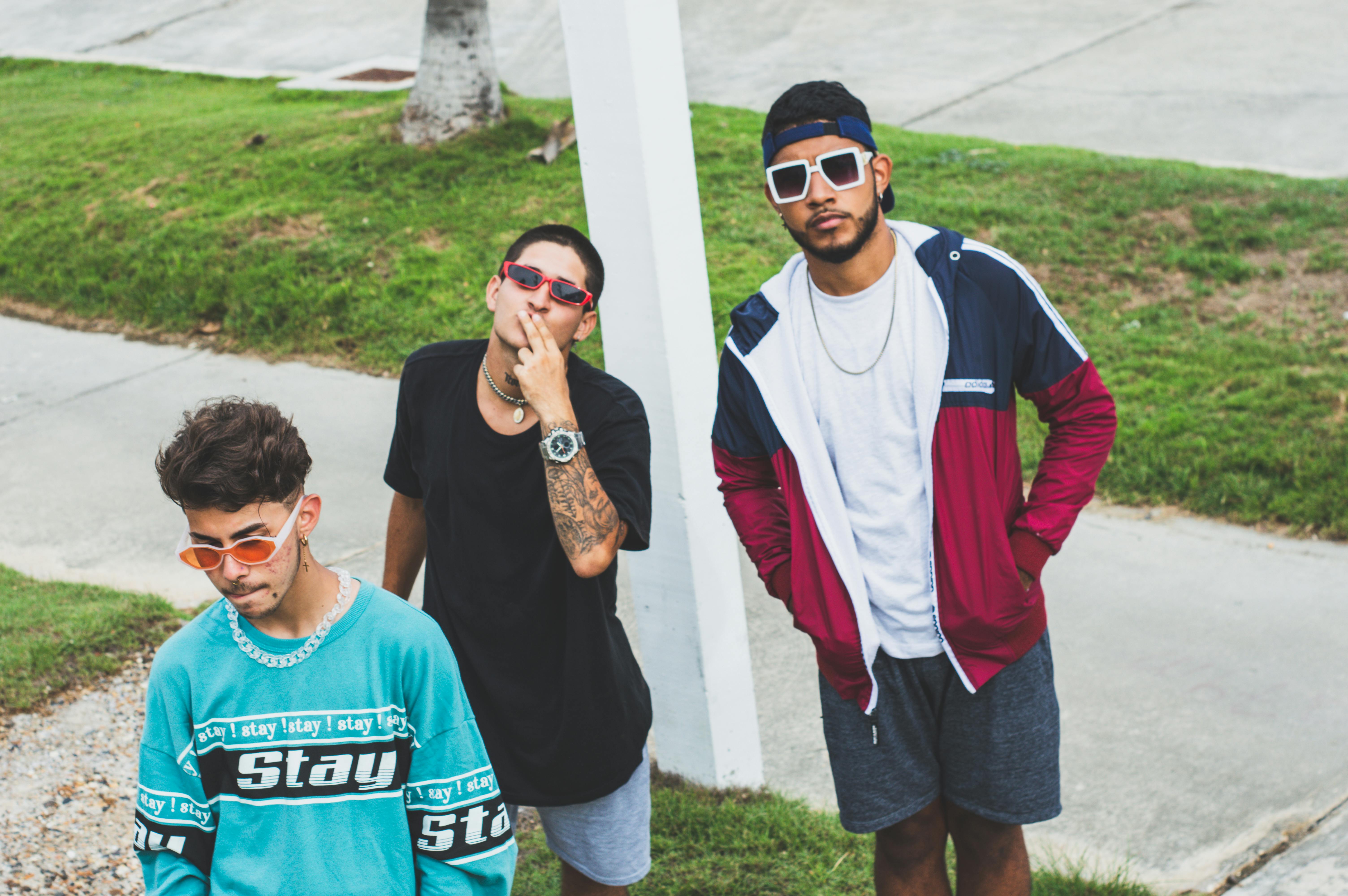 Young Men with Sunglasses Posing on Sidewalk · Free Stock Photo