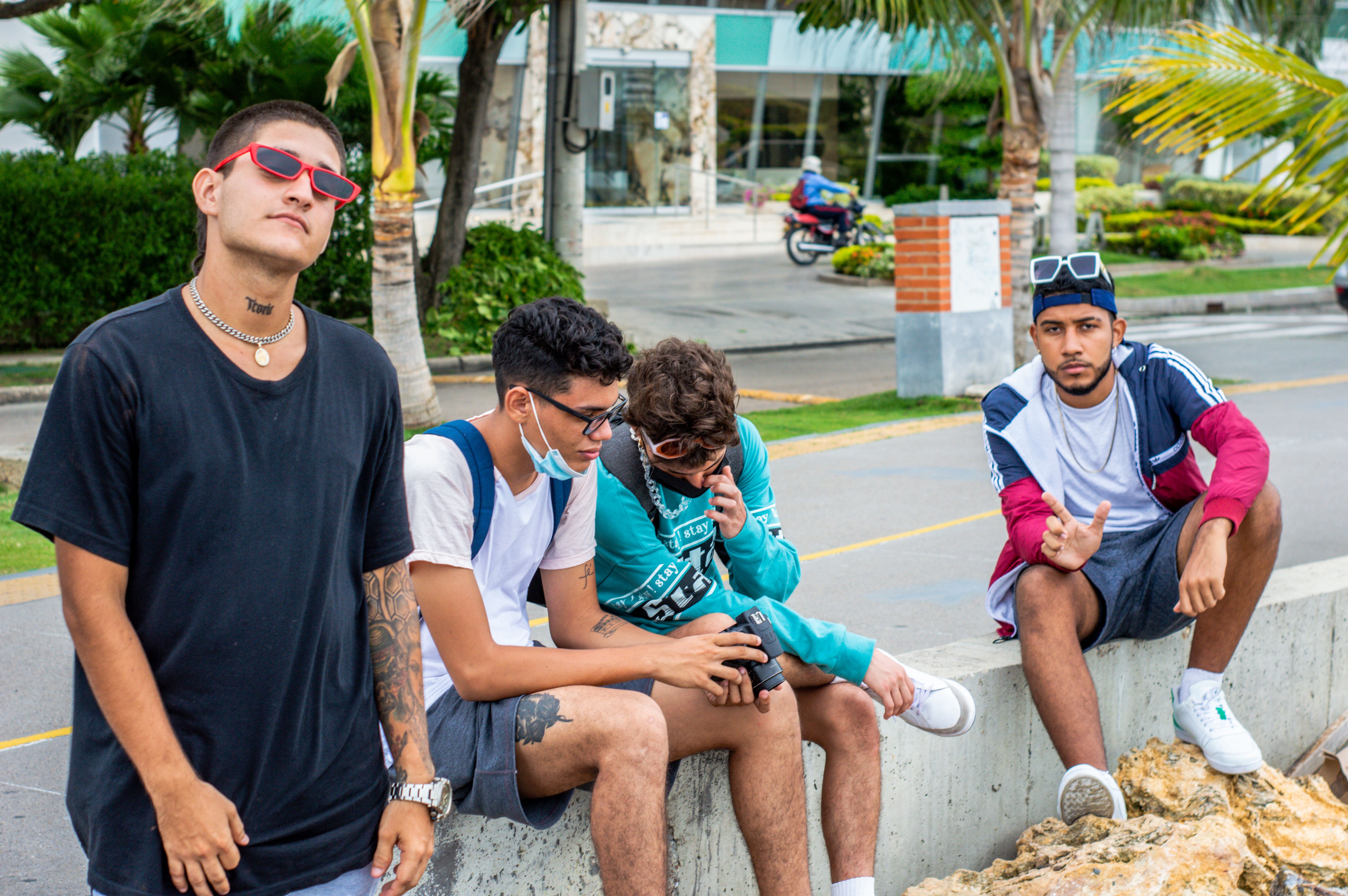 Young Men Hanging Out on Concrete Wall by Street · Free Stock Photo