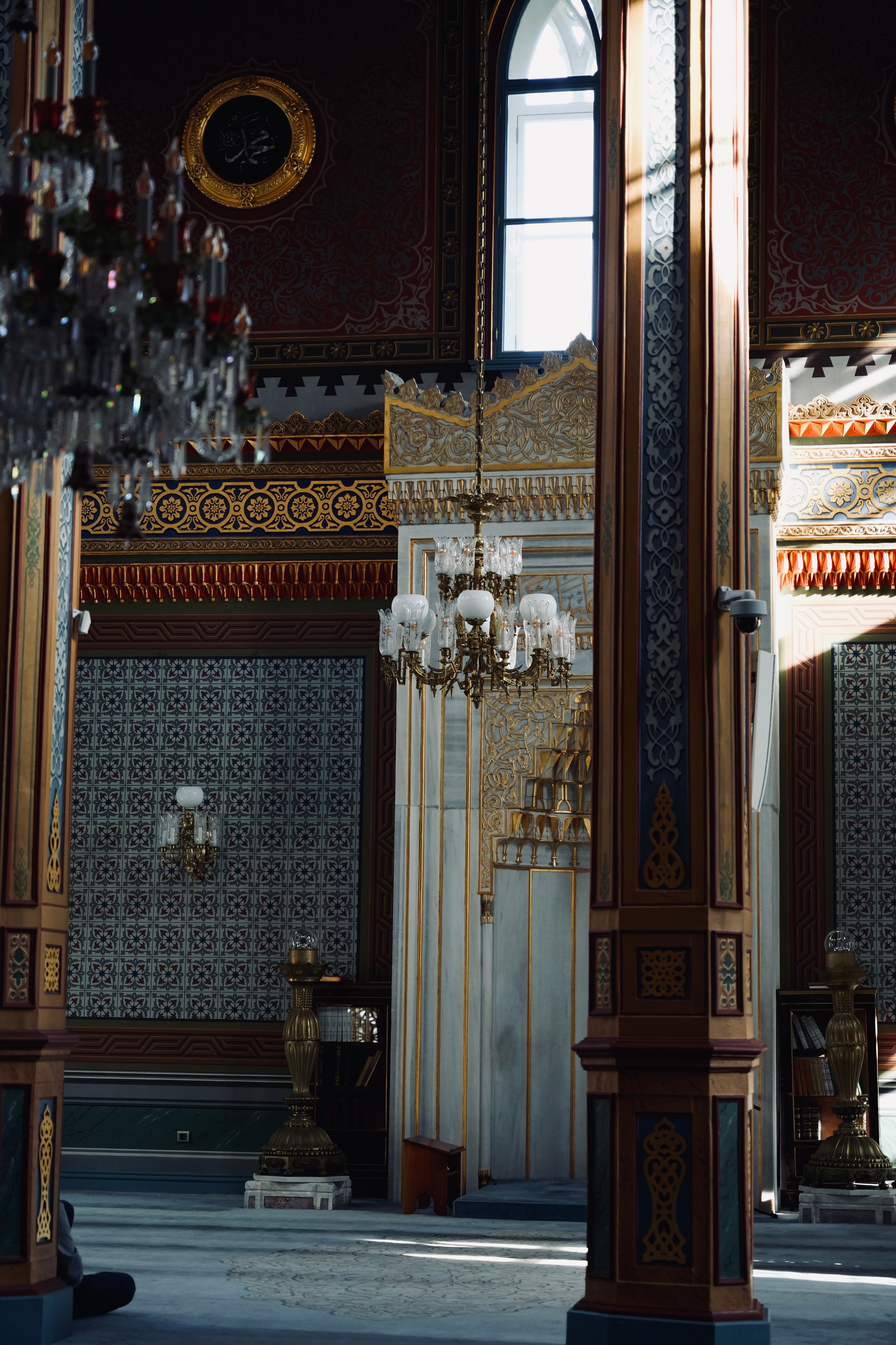 The interior of a building with ornate columns and chandeliers · Free ...