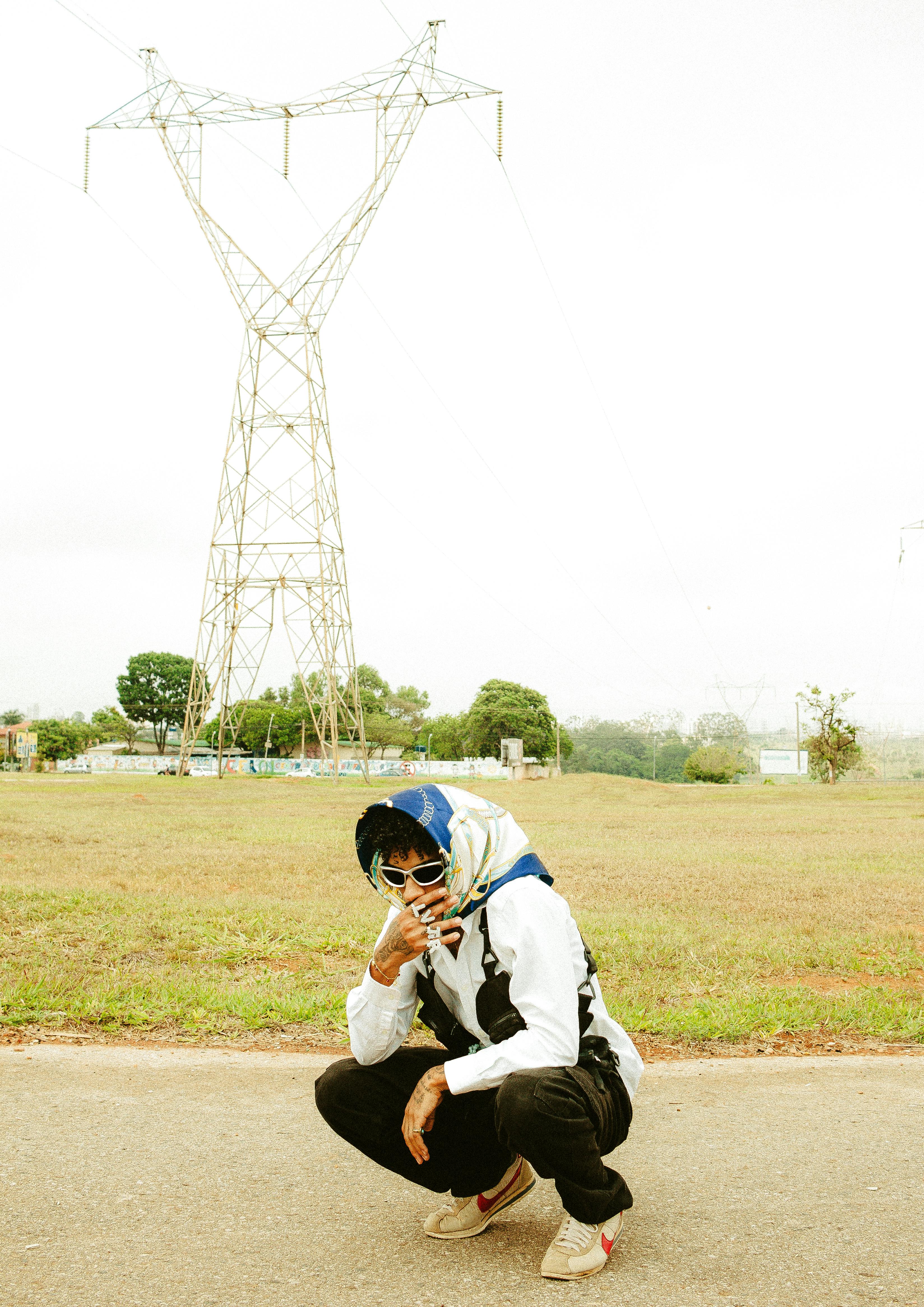 Smoking Person Crouching on Road · Free Stock Photo