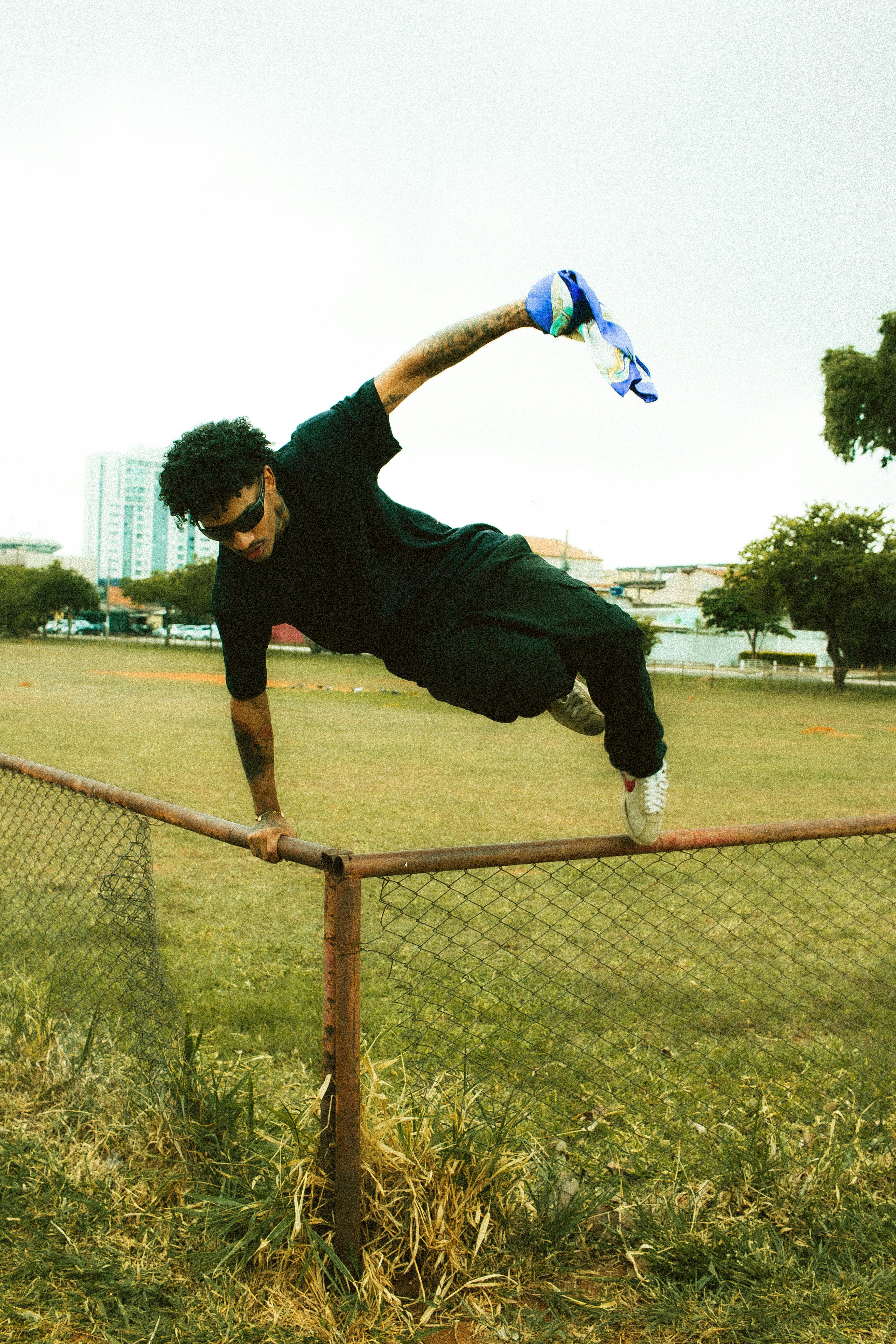 Man Jumping over Fence · Free Stock Photo
