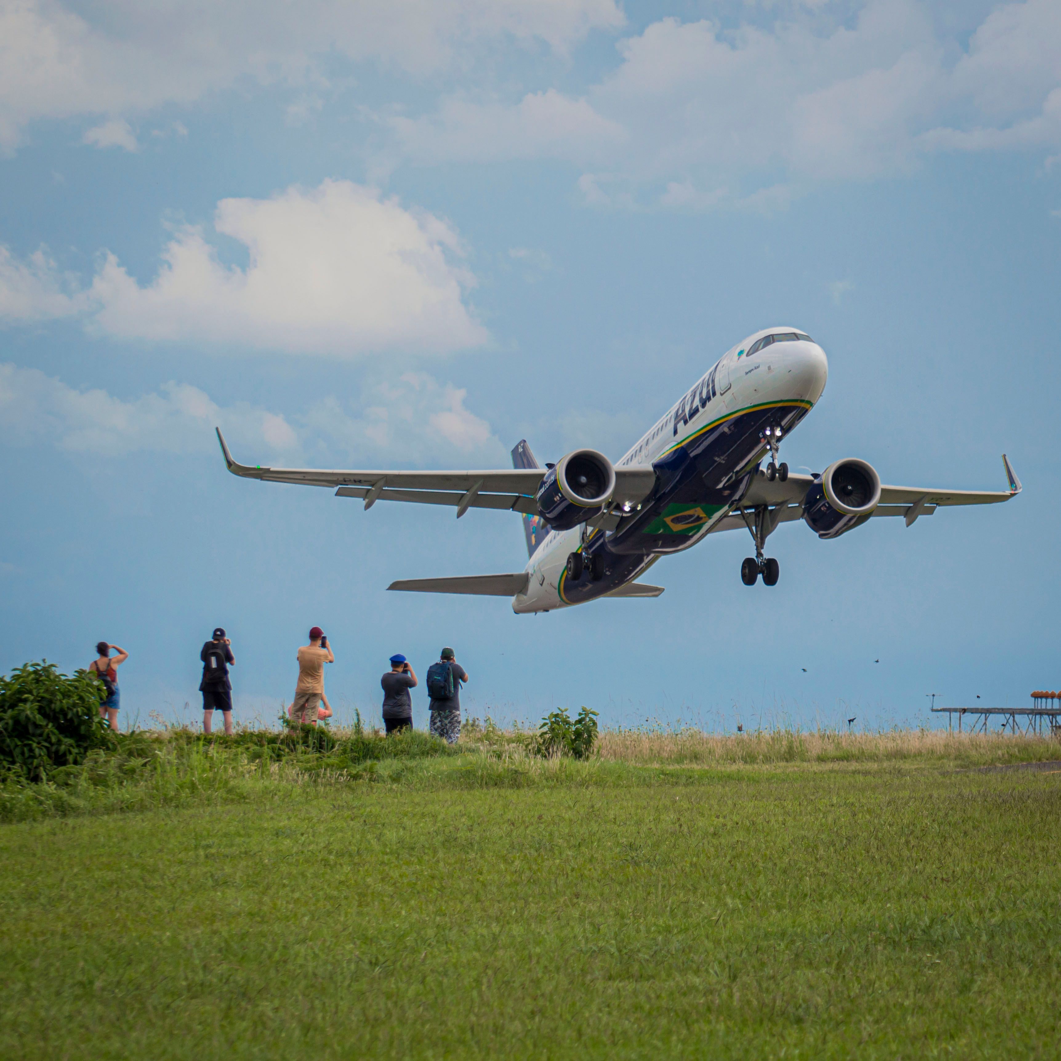 People Taking Picture of a Plane Taking Off · Free Stock Photo
