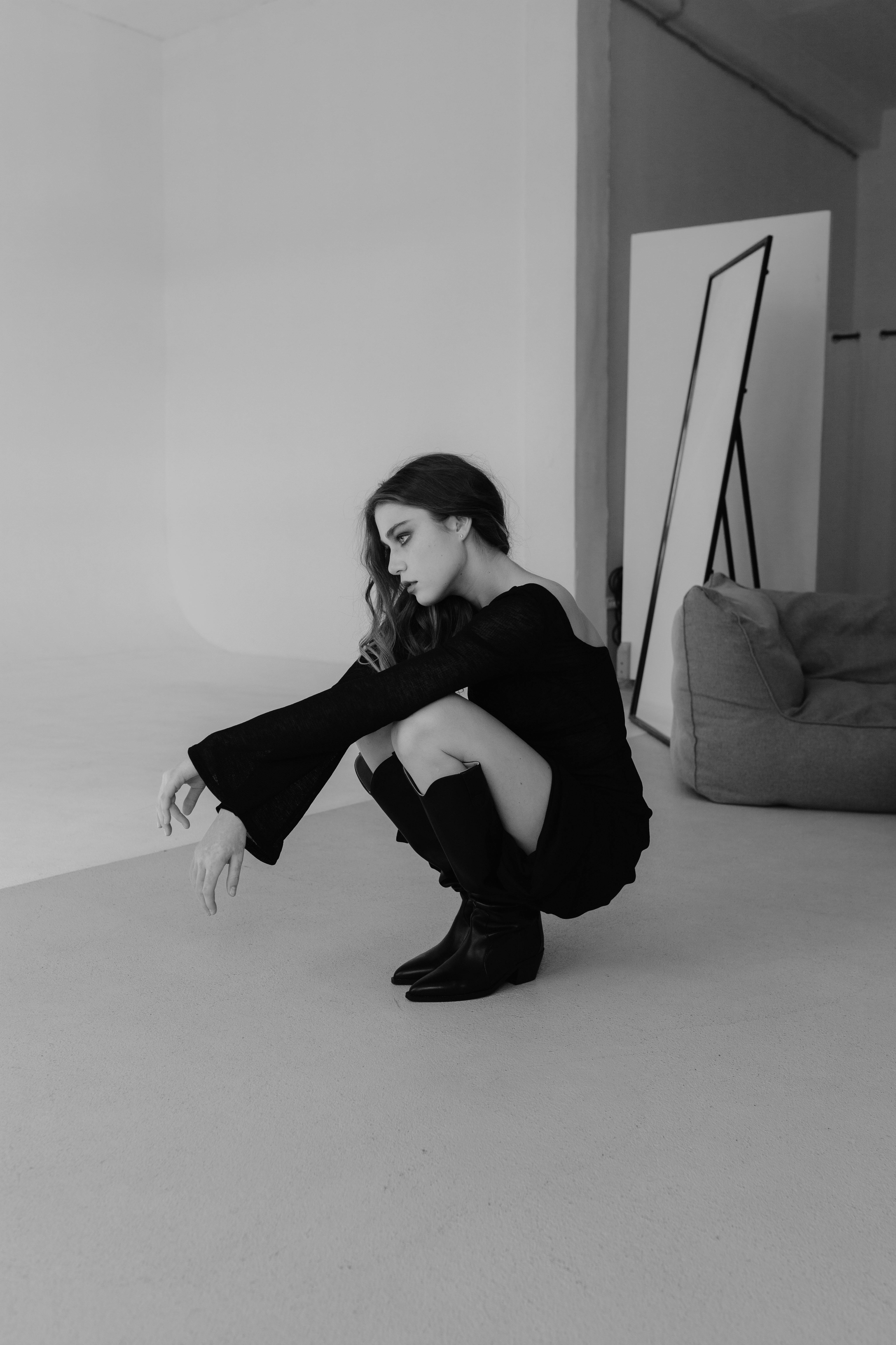 Black and White Photo of a Crouching Woman · Free Stock Photo