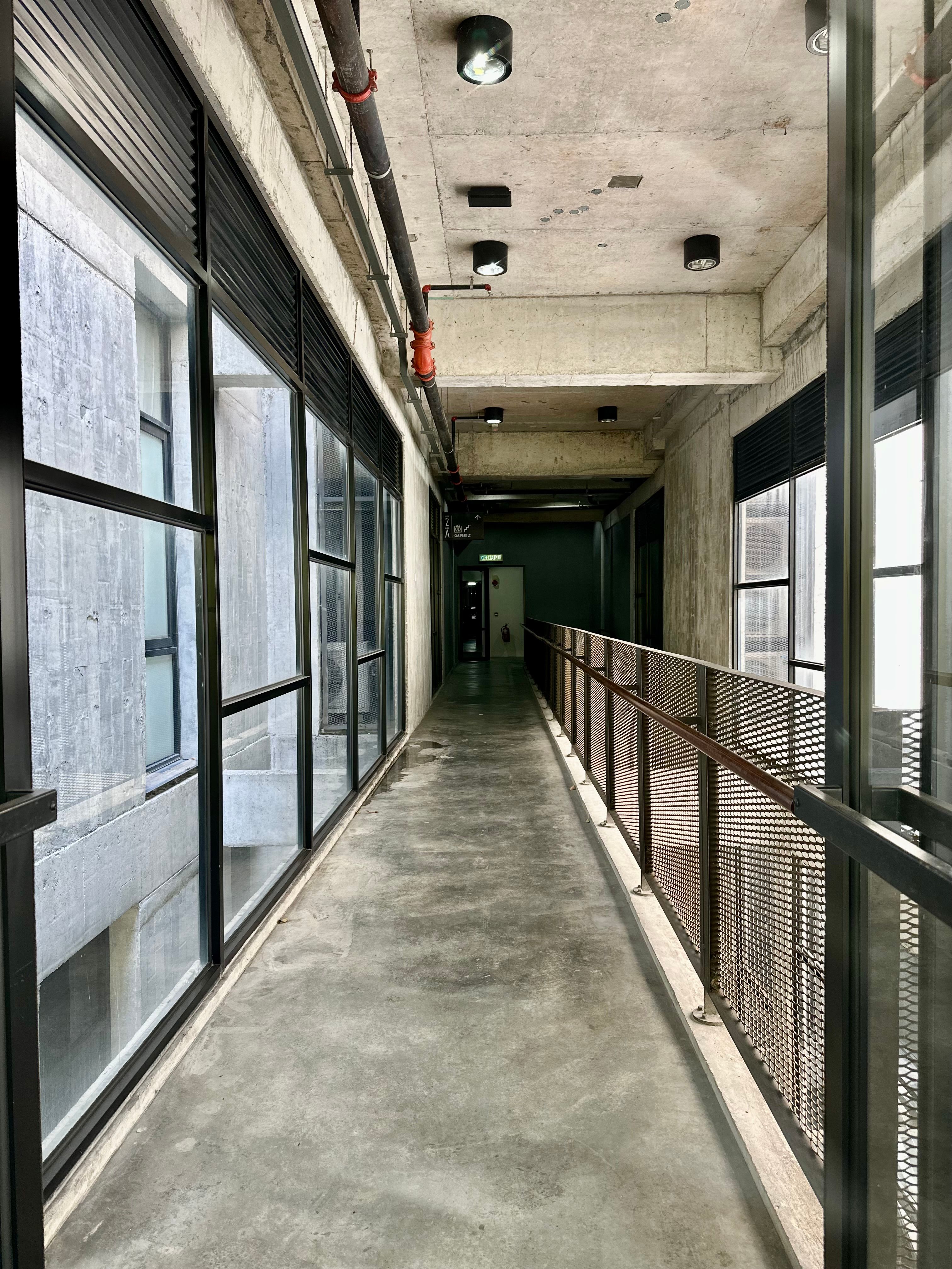 Empty Corridor between Windows and Railing · Free Stock Photo