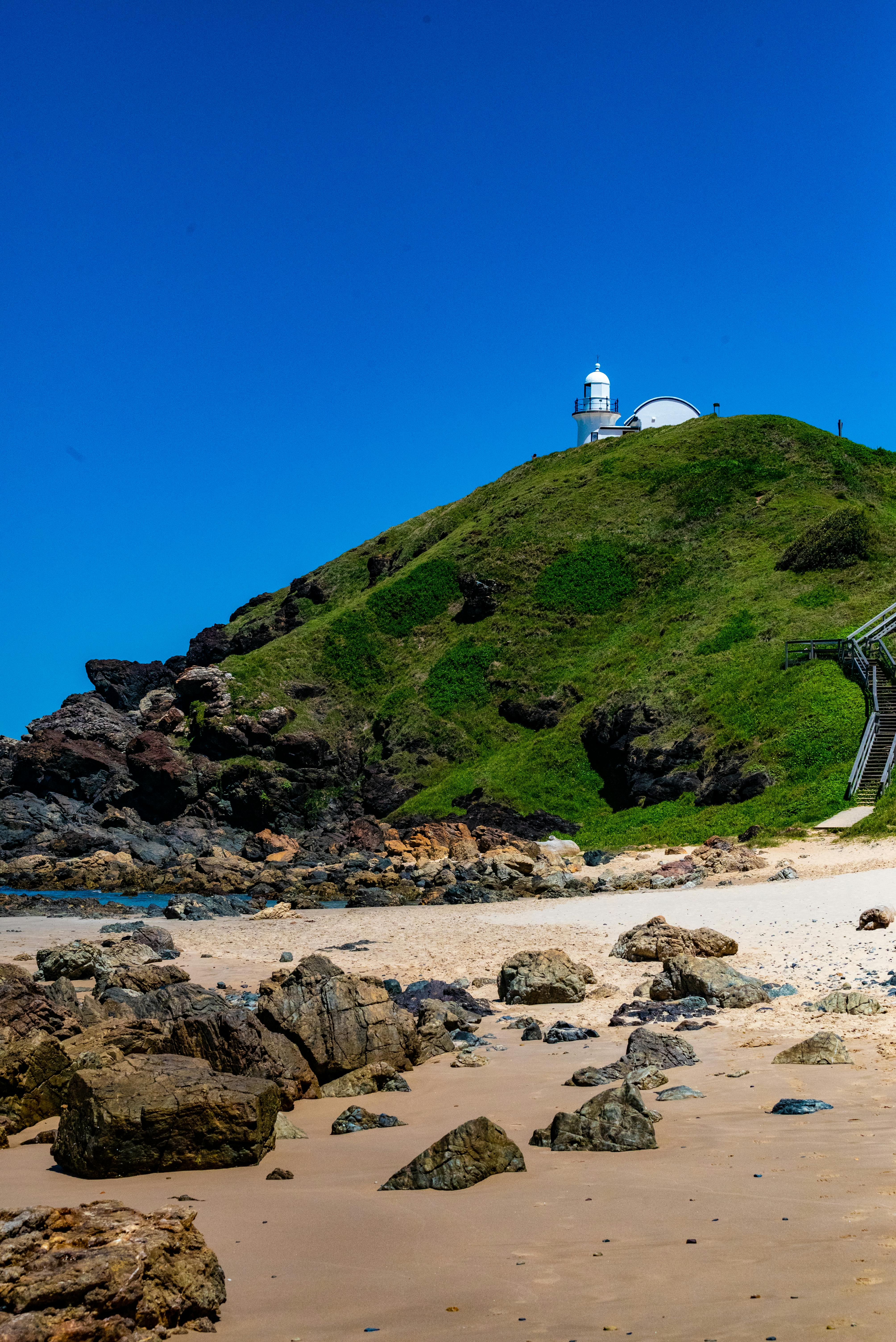 Tacking Point Lighthouse on a Green Hill Above Little Bay Nature ...