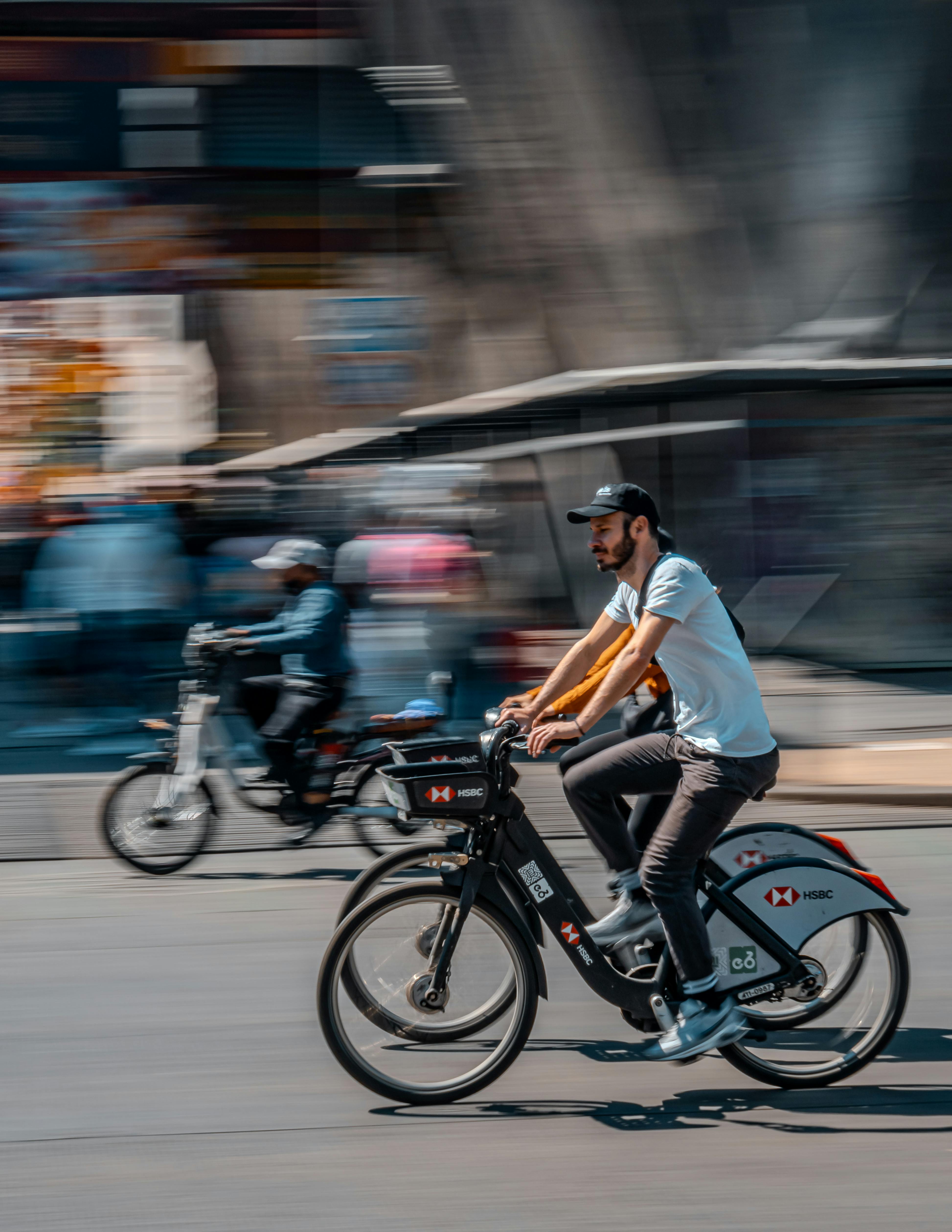 Man Riding Bicycle on City Street · Free Stock Photo
