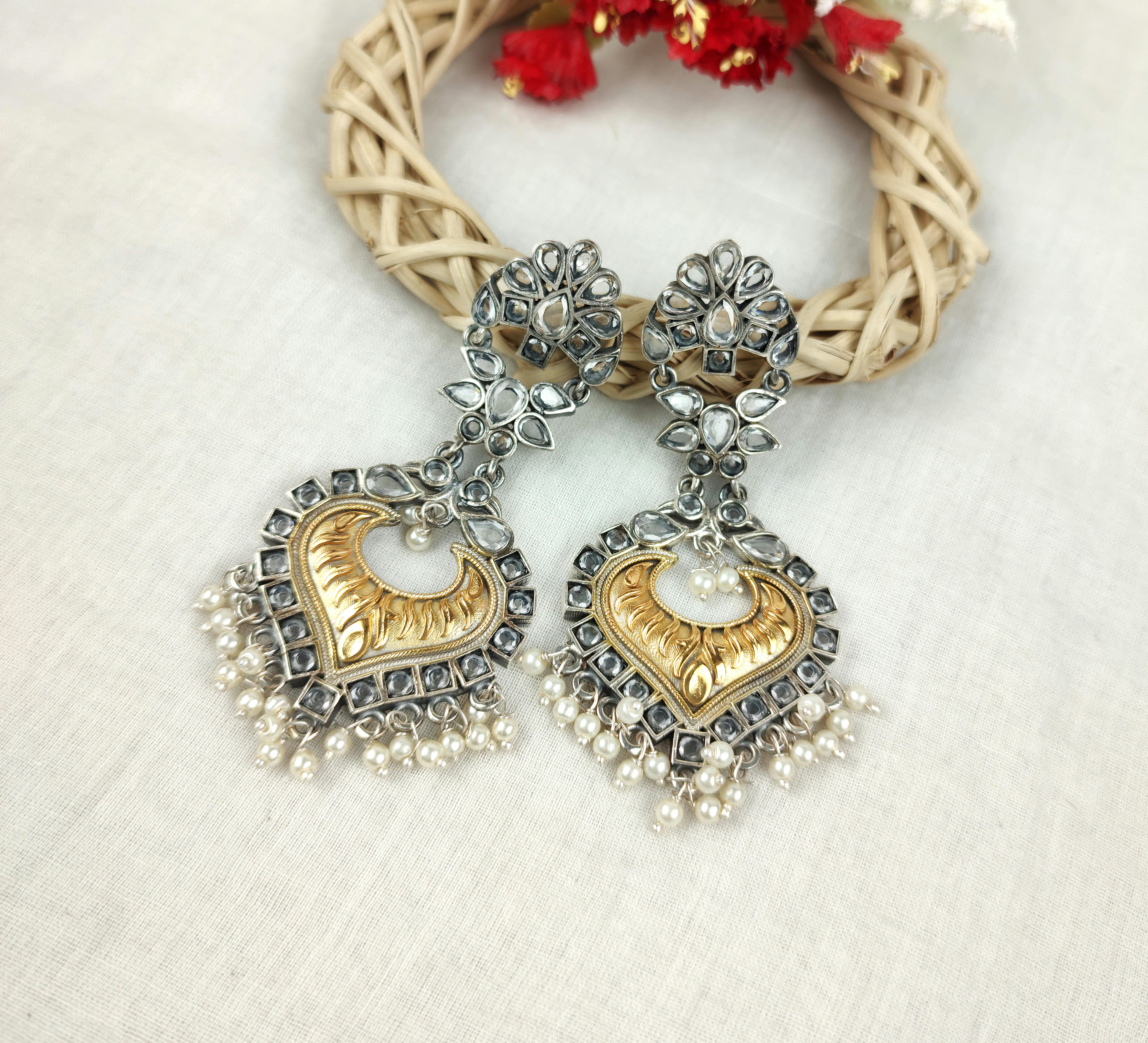 Ornamental Earrings Displayed on a Straw Band · Free Stock Photo