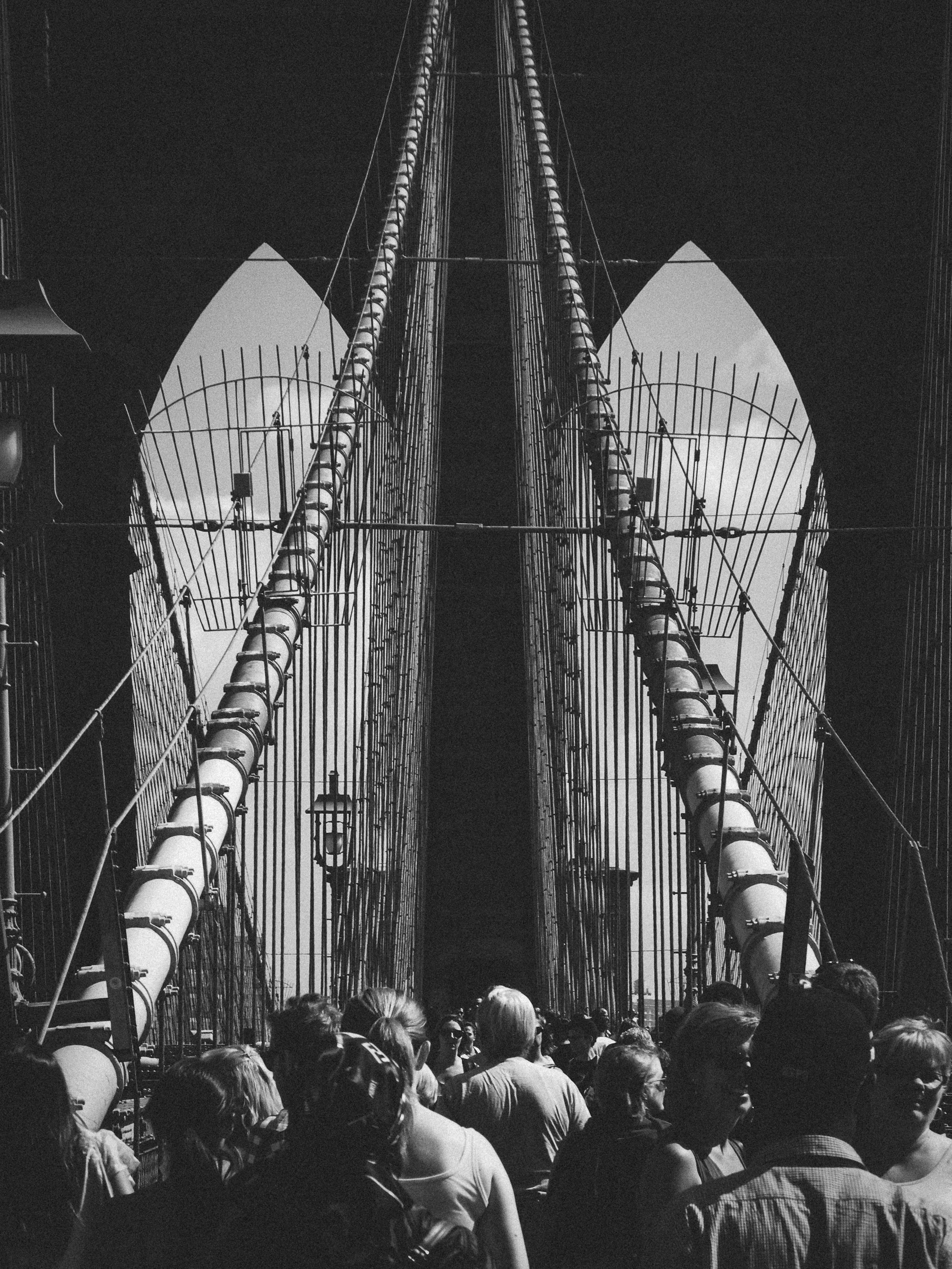 Symmetrical Shot of a Crowd on a Suspension Bridge · Free Stock Photo