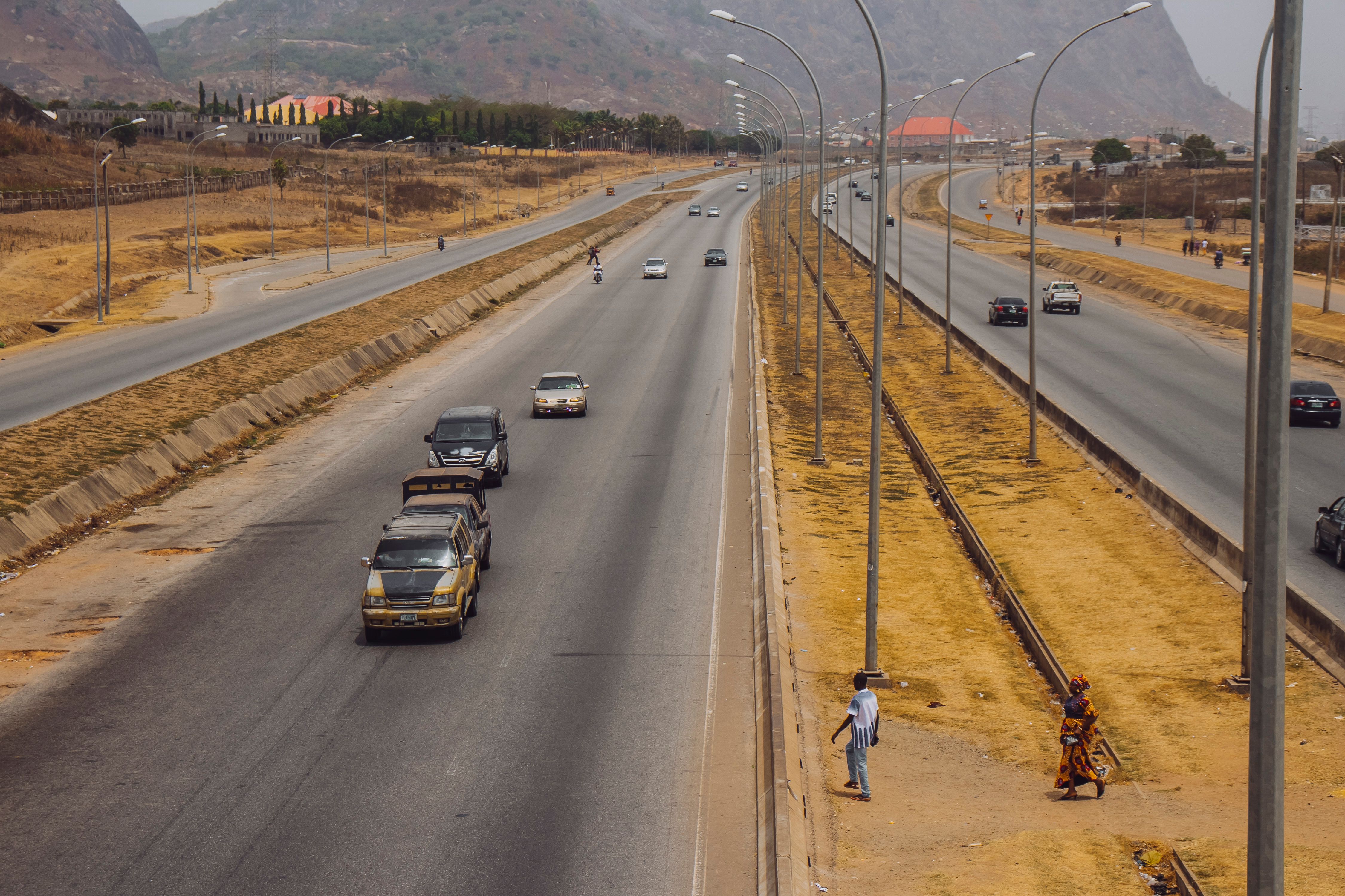 Woman and Man Crossing Highway in Nigeria · Free Stock Photo