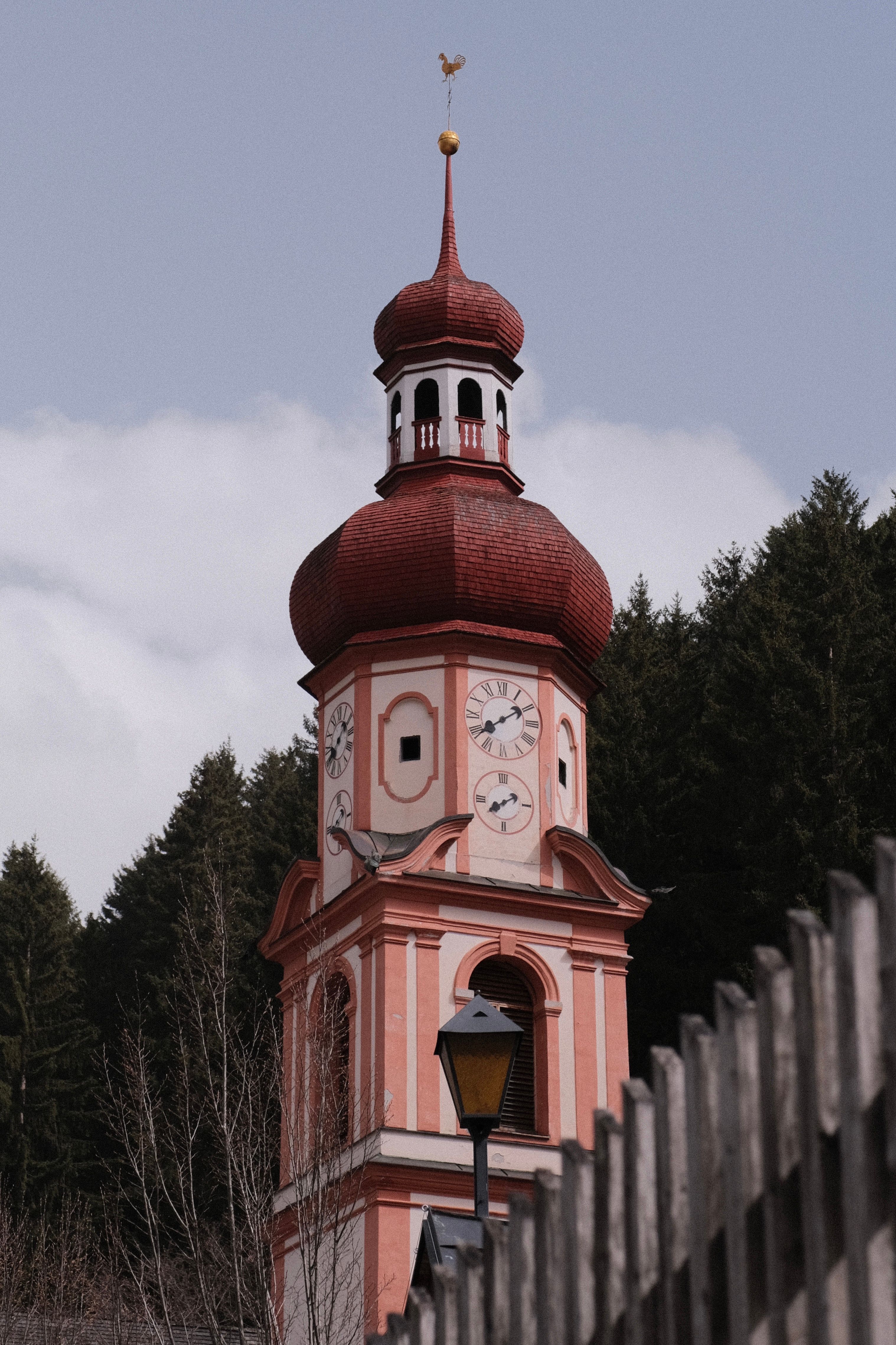 A clock tower with a red roof and a white clock · Free Stock Photo