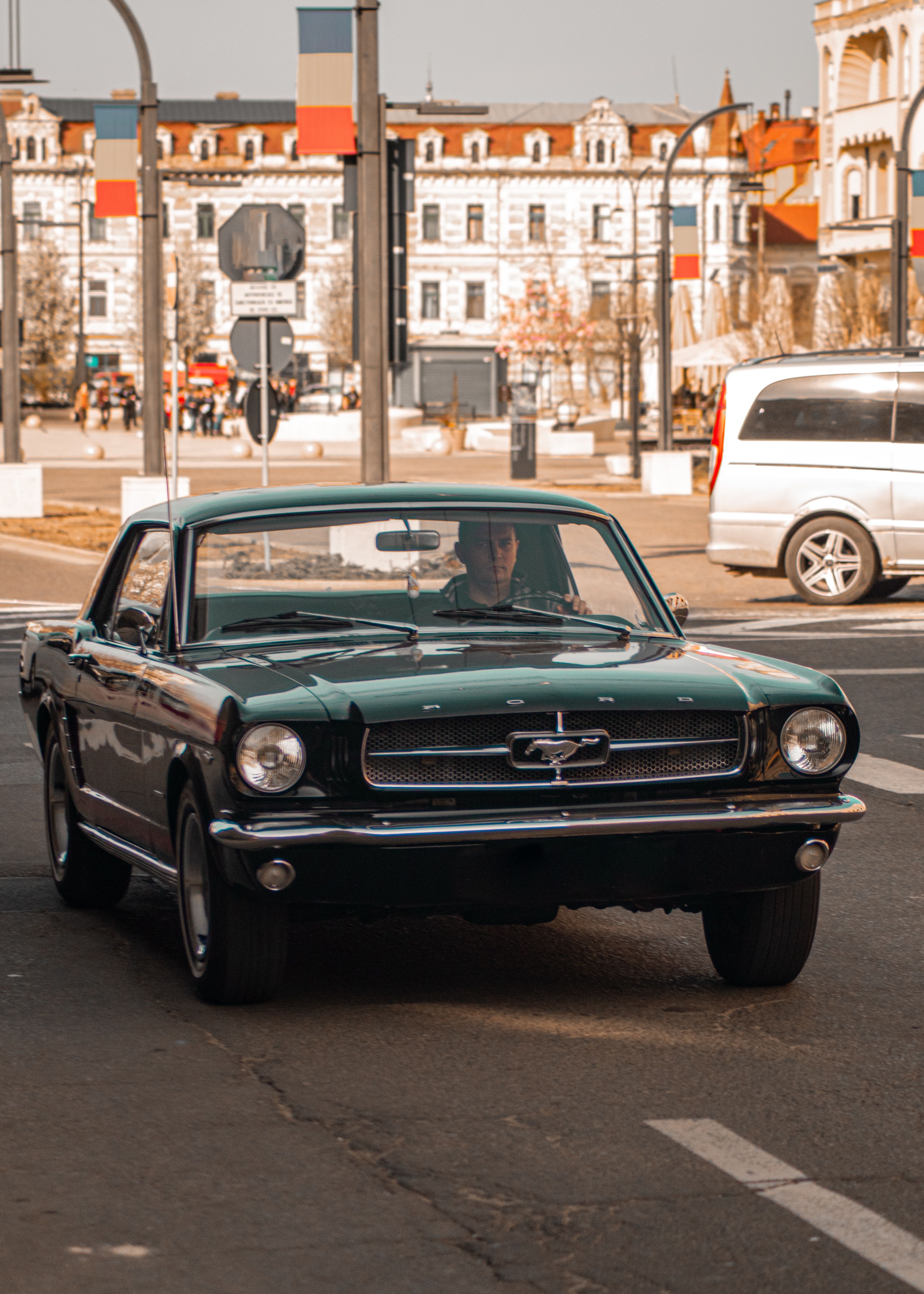 Green Ford Mustang on a City Road · Free Stock Photo