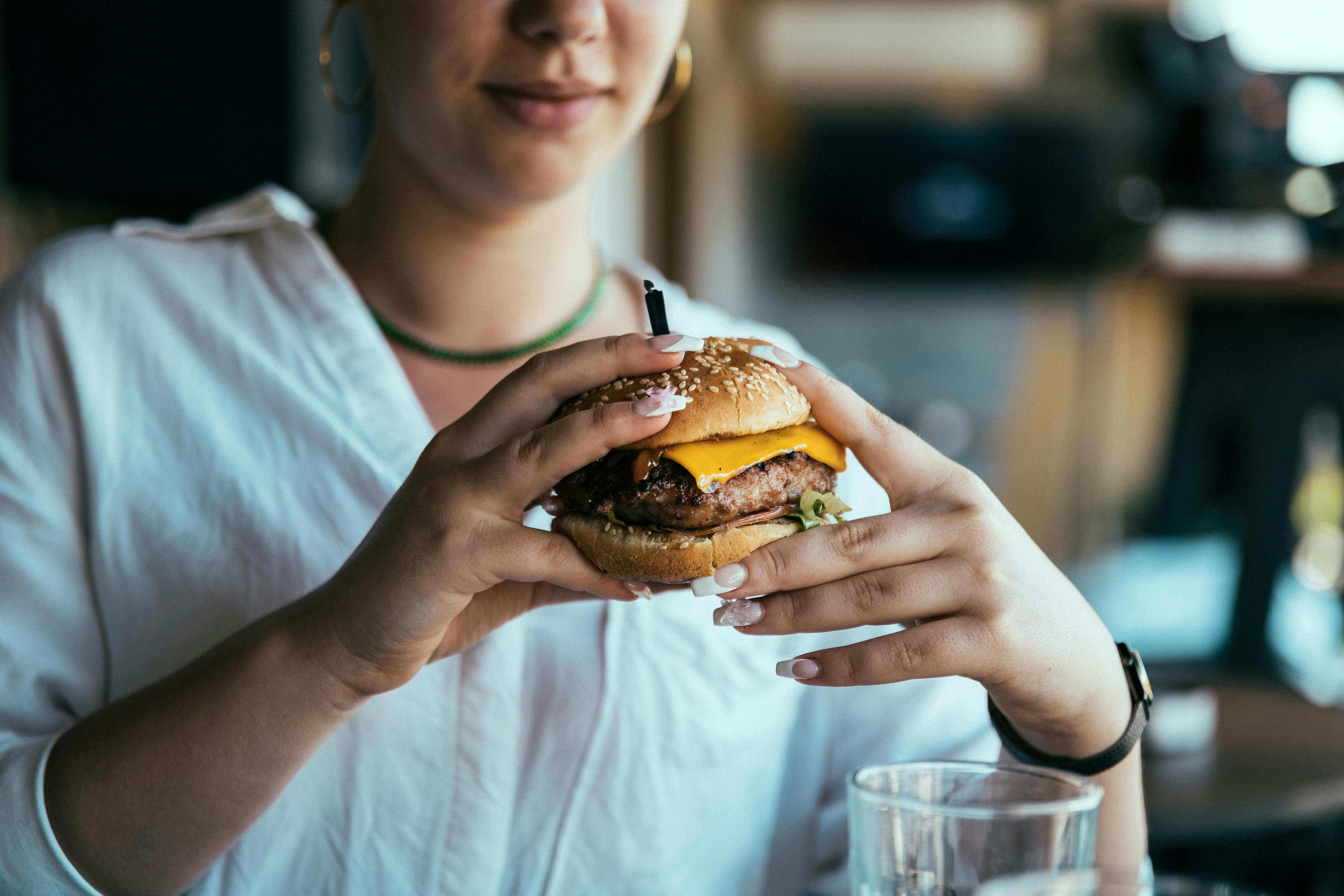 Woman Eating Cheeseburger · Free Stock Photo