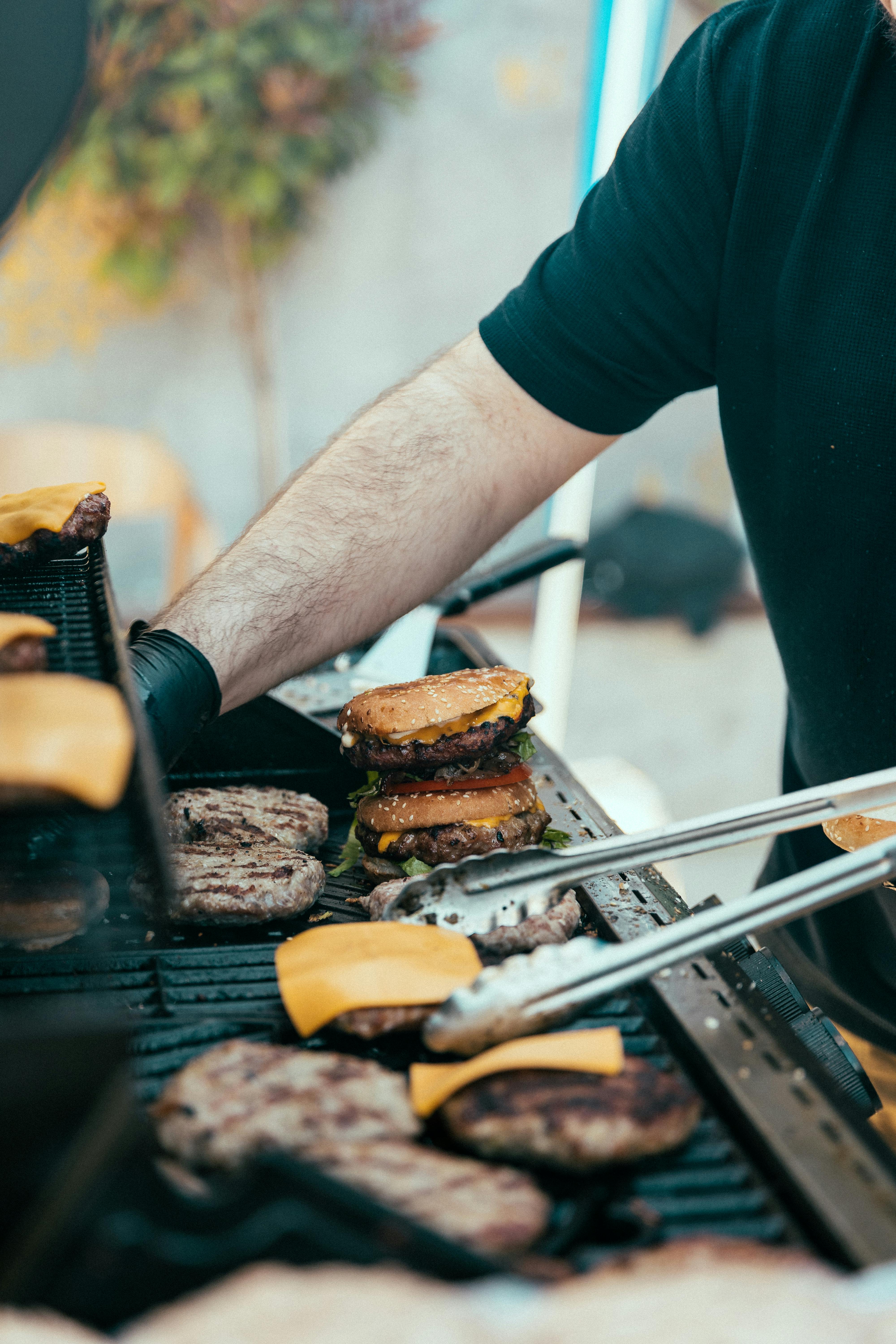 Man Making Burgers on Barbecue · Free Stock Photo